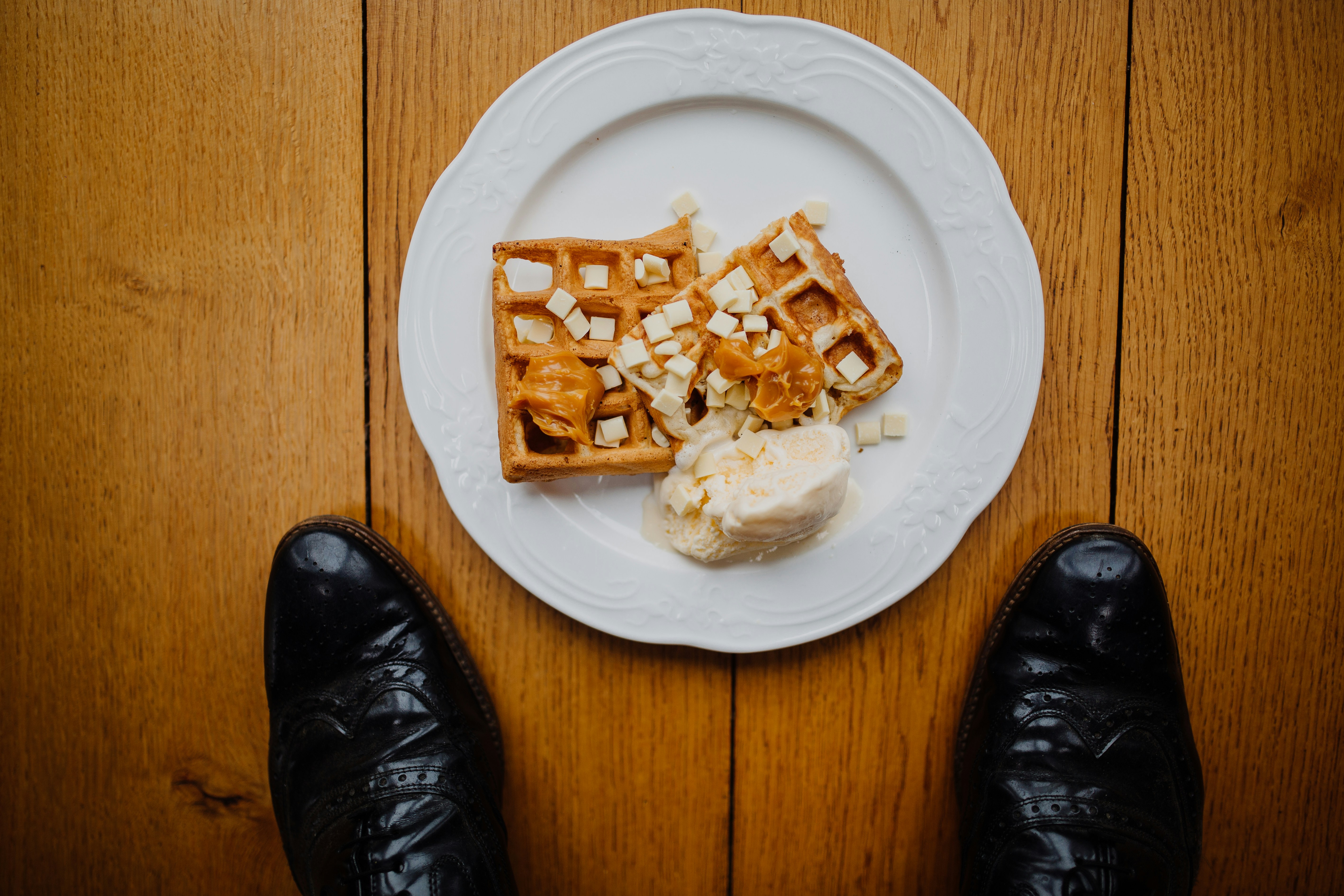 Boots and Waffles: A Tiny Dessert Moment on a Wooden Floor