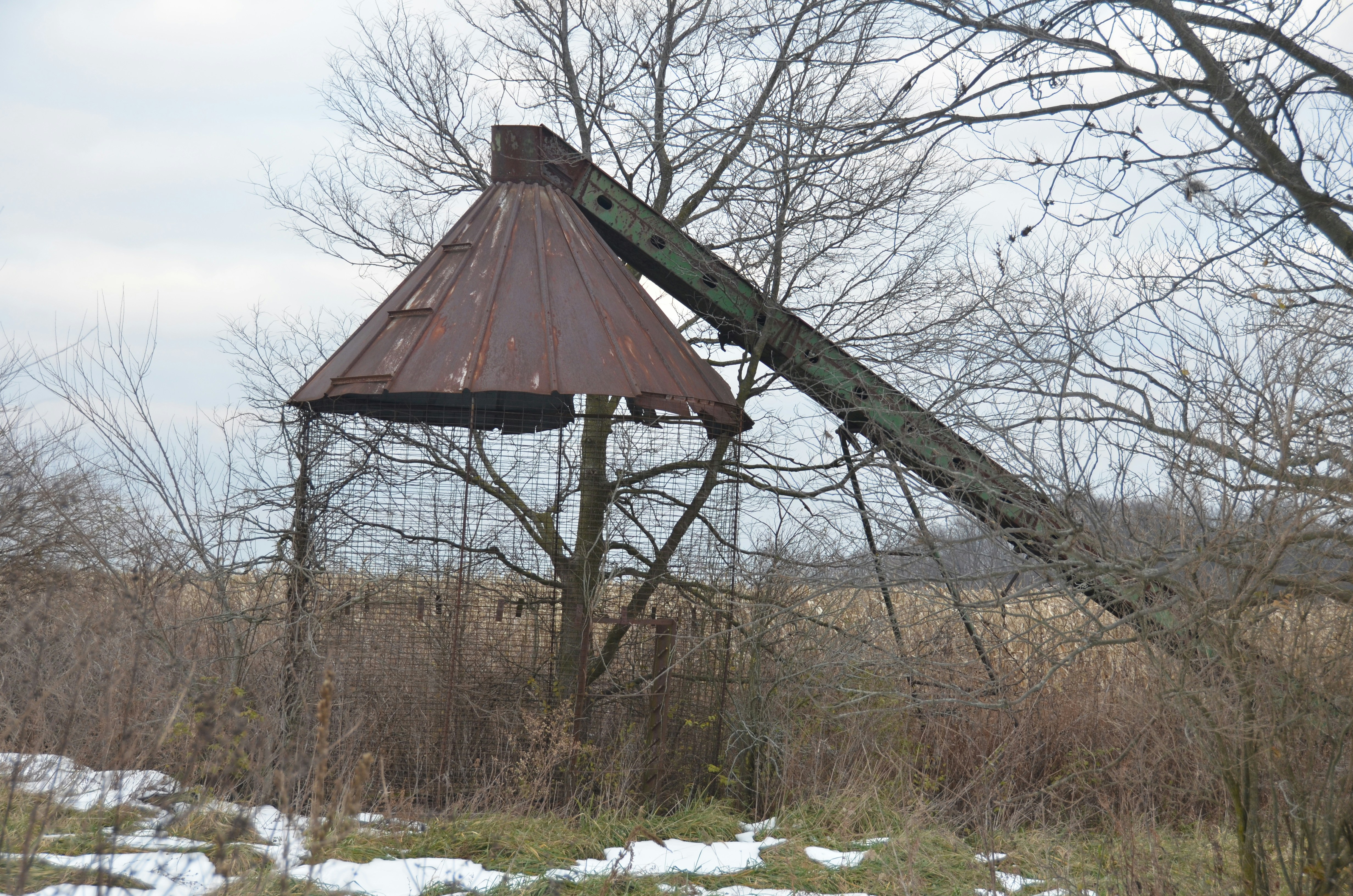 Rusty old corn crib with corn elevator