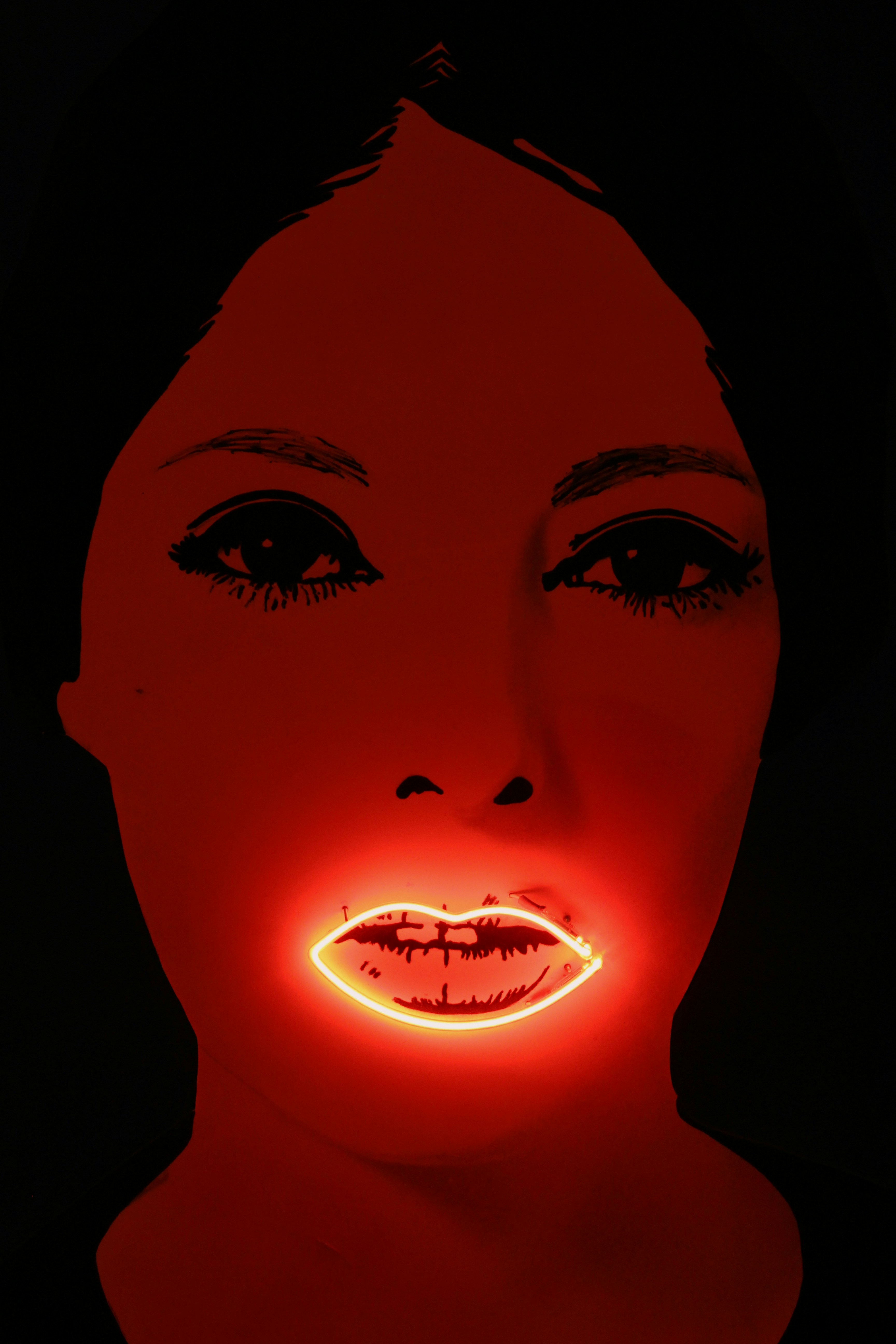 Crimson Halo: Neon Liplight Defines a Portrait in Darkness
