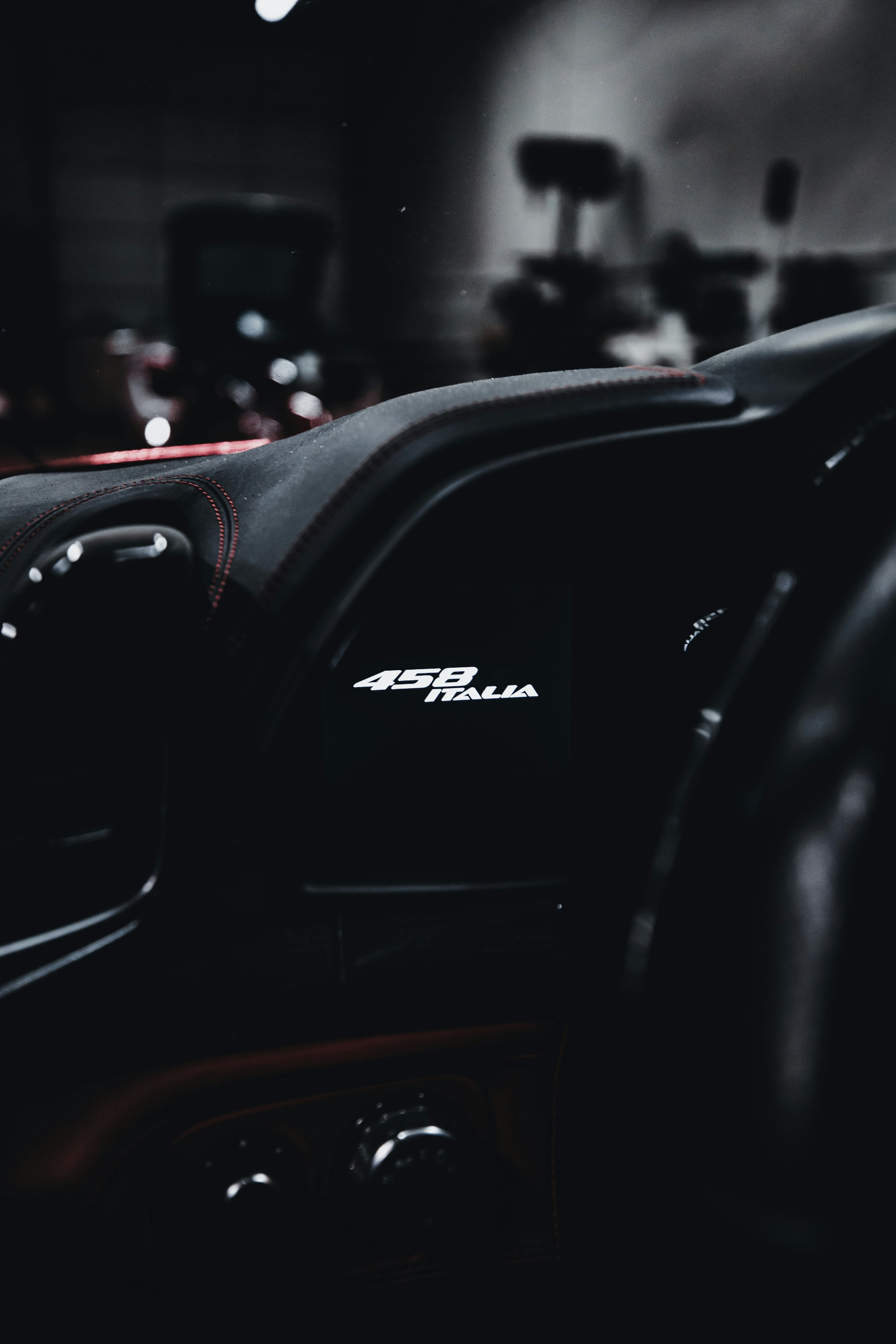 Bold interior: the 458 Italia badge glowing in a dark car cabin