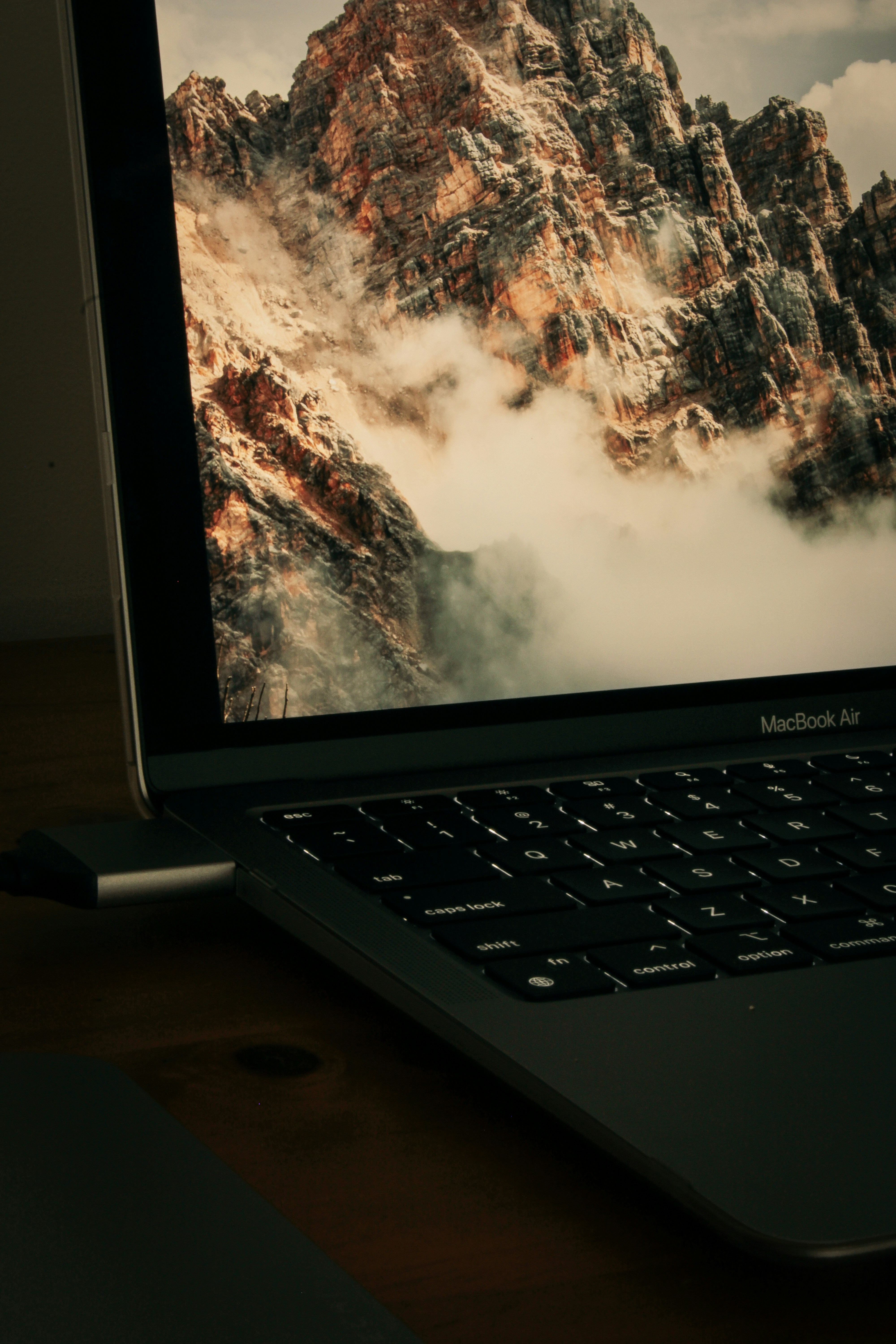 Rugged Peaks Piercing a MacBook Screen