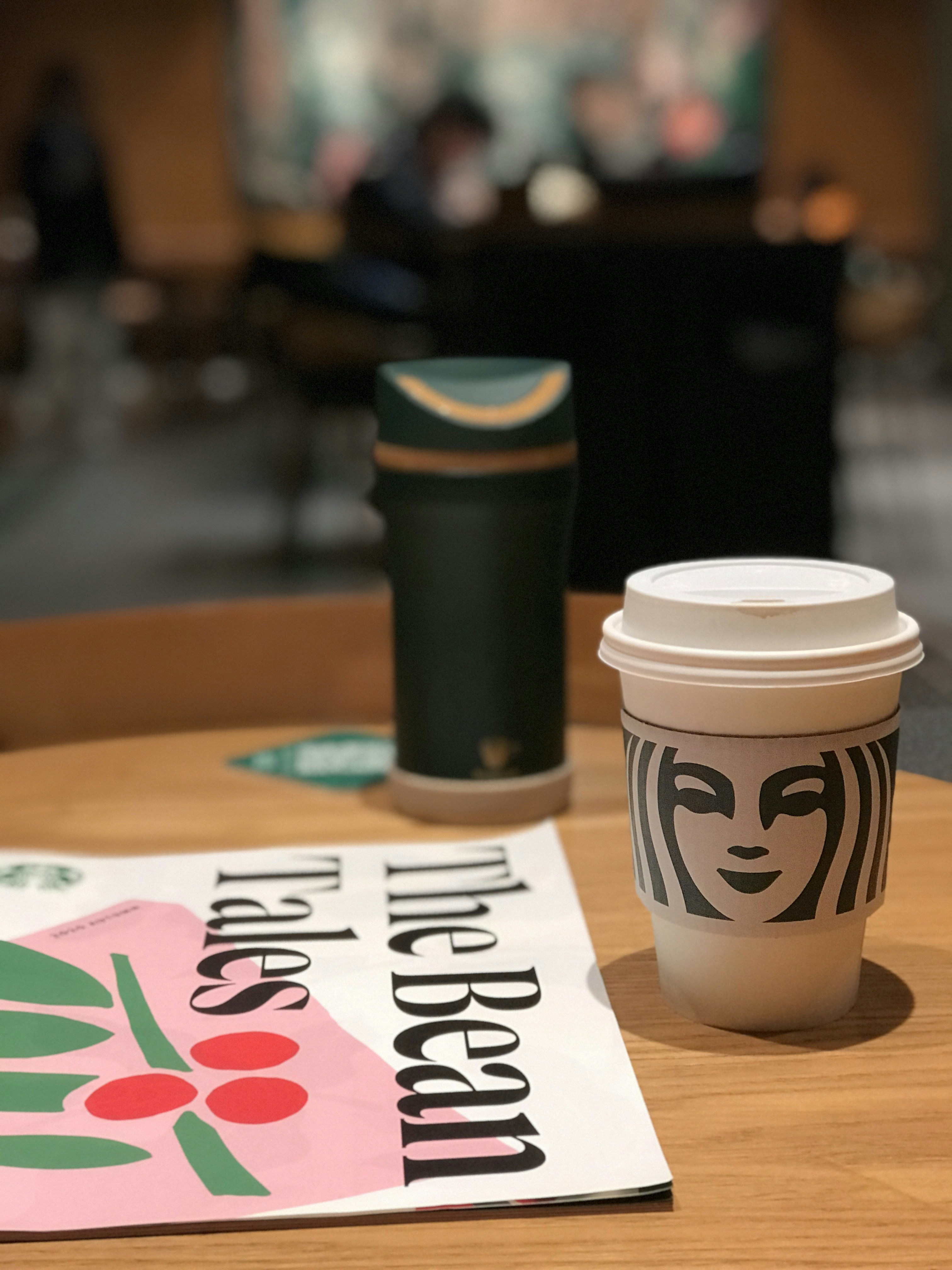 Concrete Moment at a Quiet Café: Starbucks Cup and Barista View