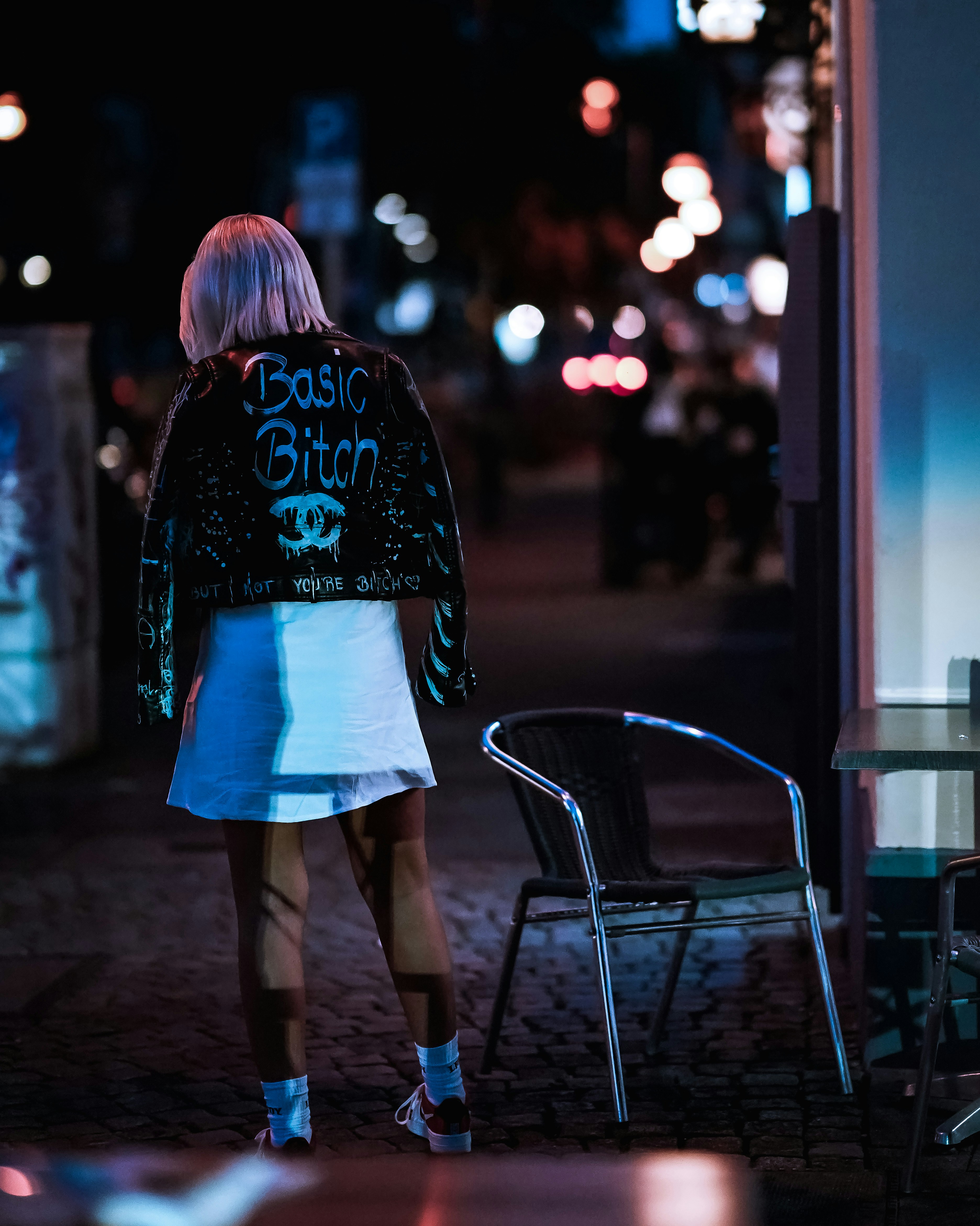 Woman in white mini skirt standing near glass window photo – Free ...