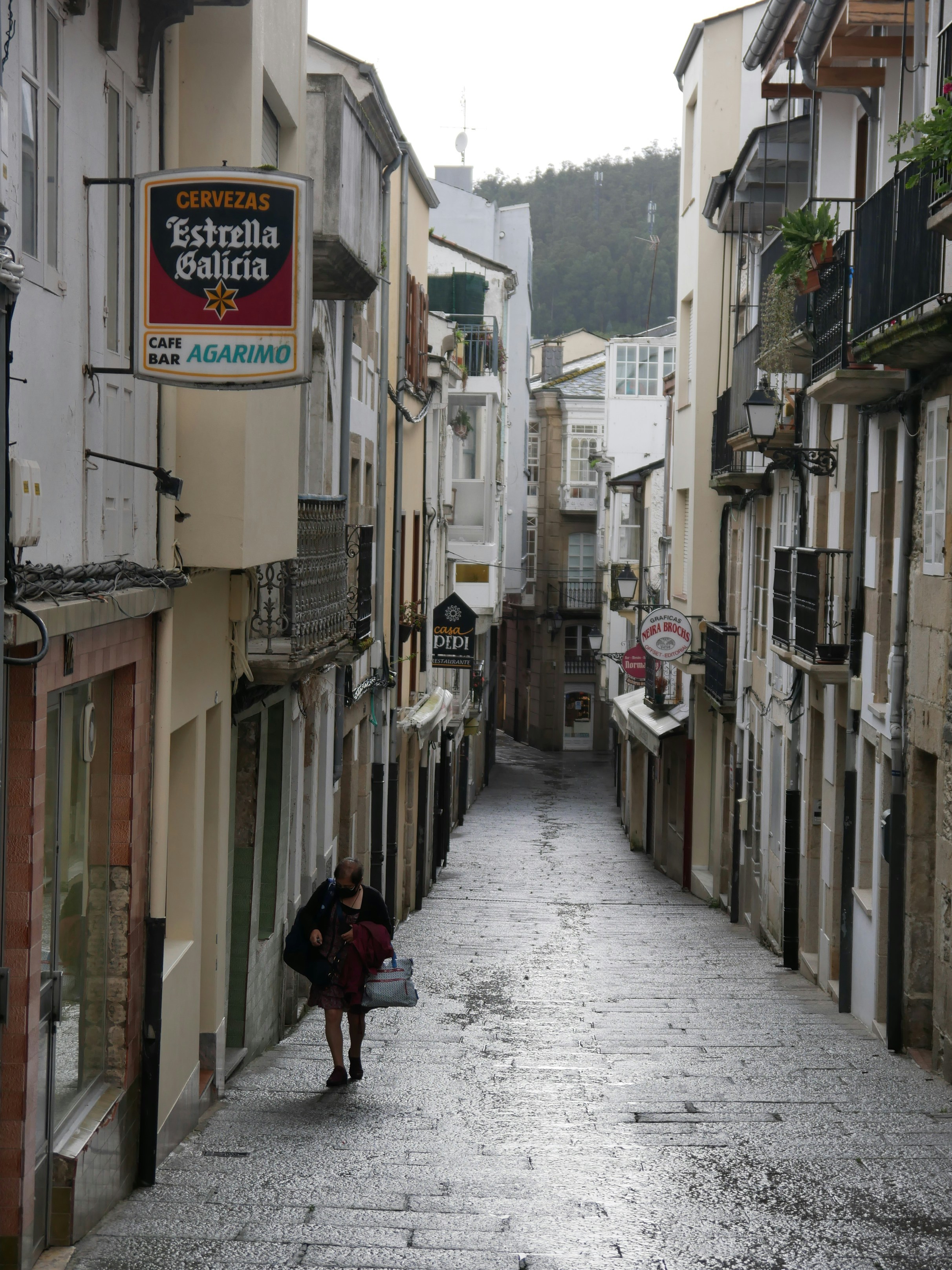 Cobbled Galician Calle: A Lone Pedestrian Reaches the Quiet End