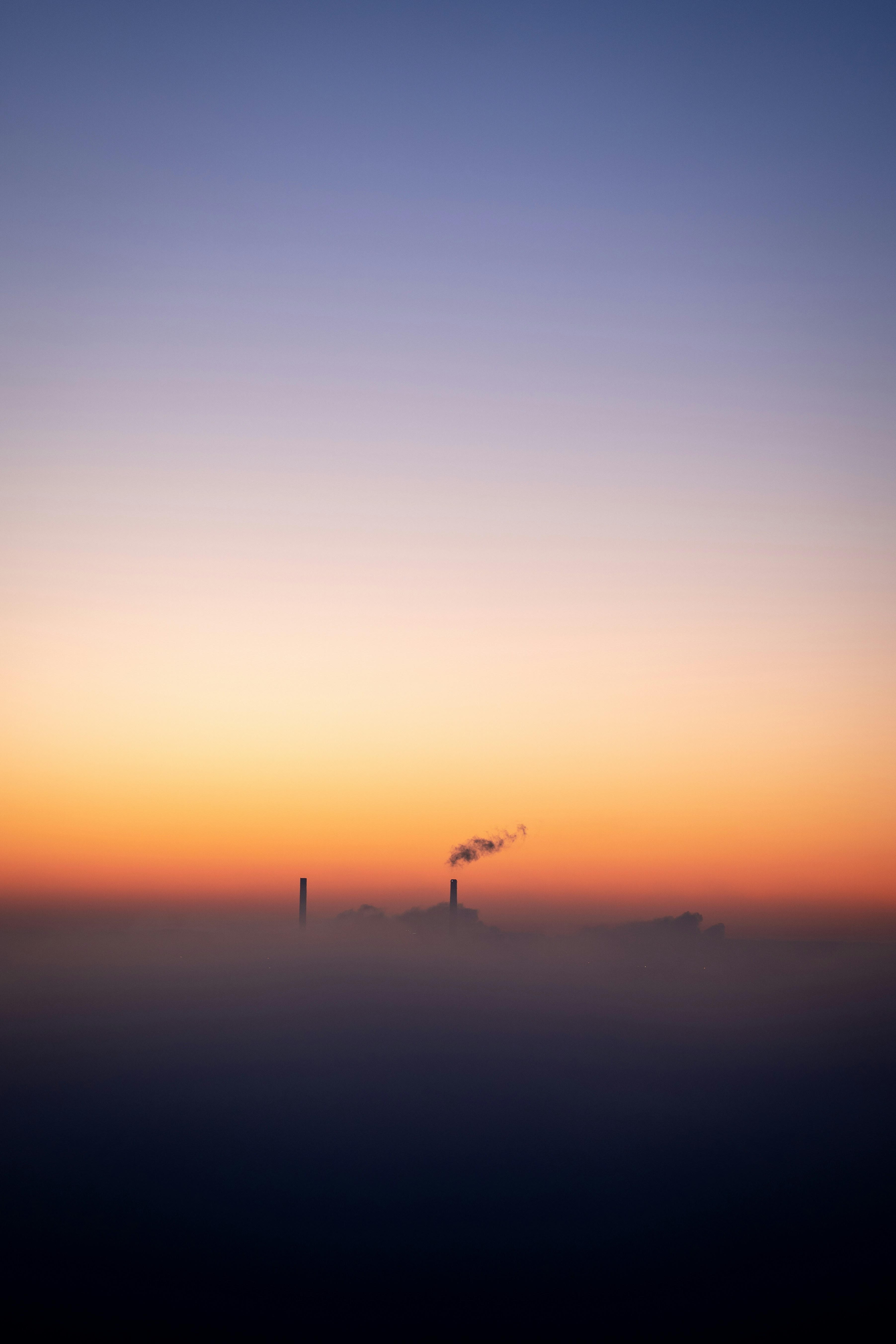 silhouette of birds flying over the sea during sunset