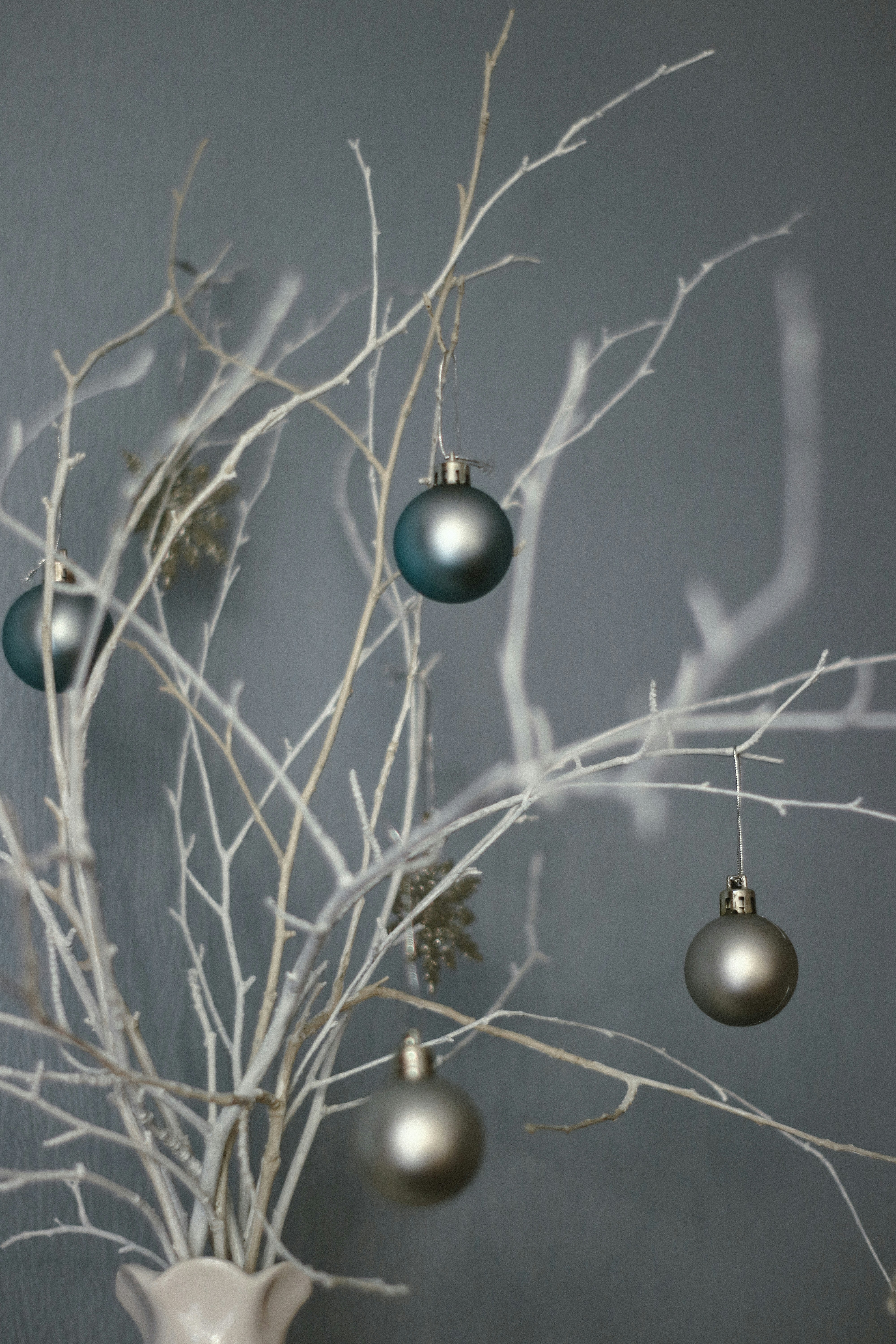 Turquoise bauble suspended in a frost-kissed twigscape