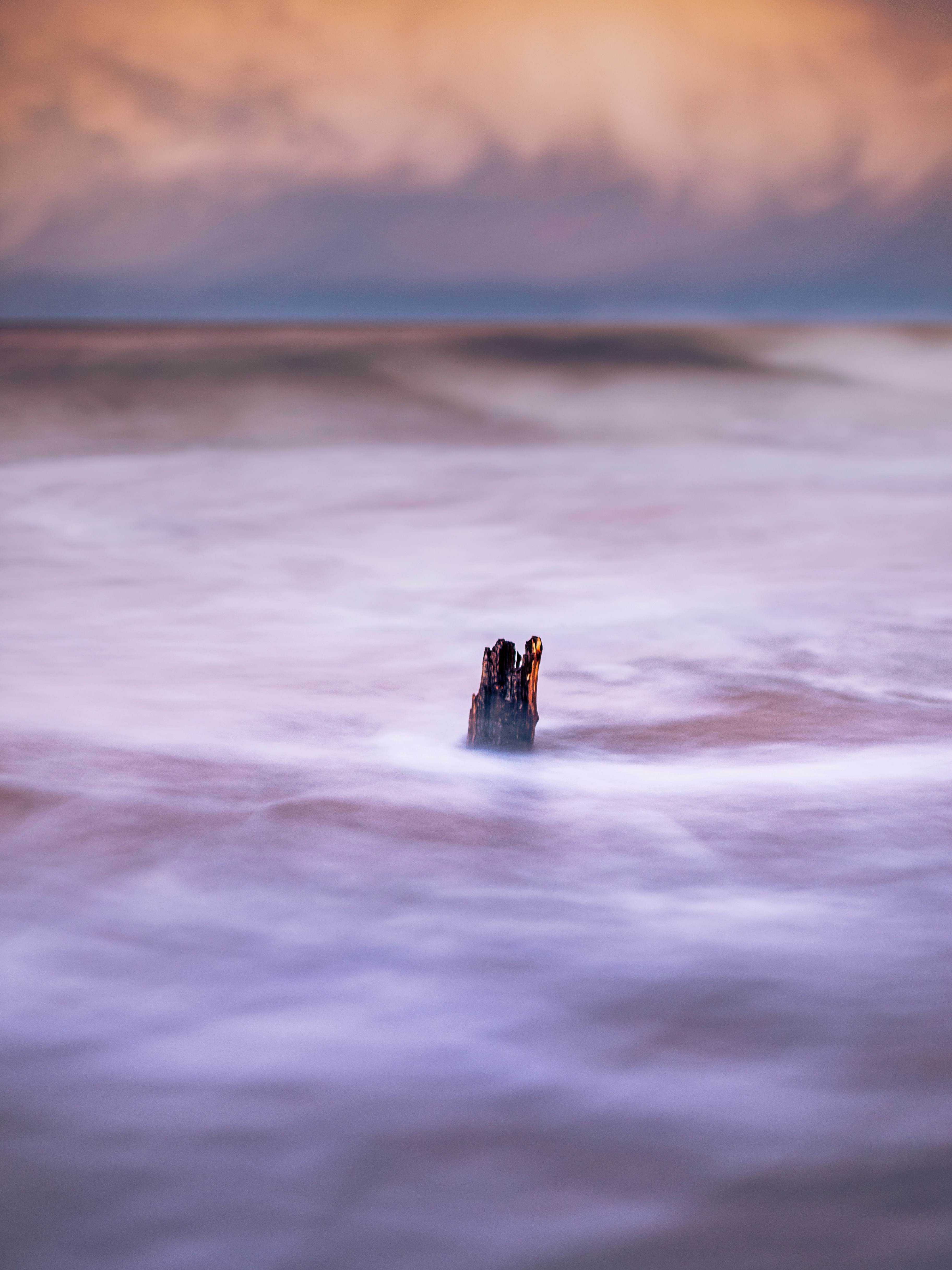 Lone Weathered Post Rising From Velvet Tide at Sunset
