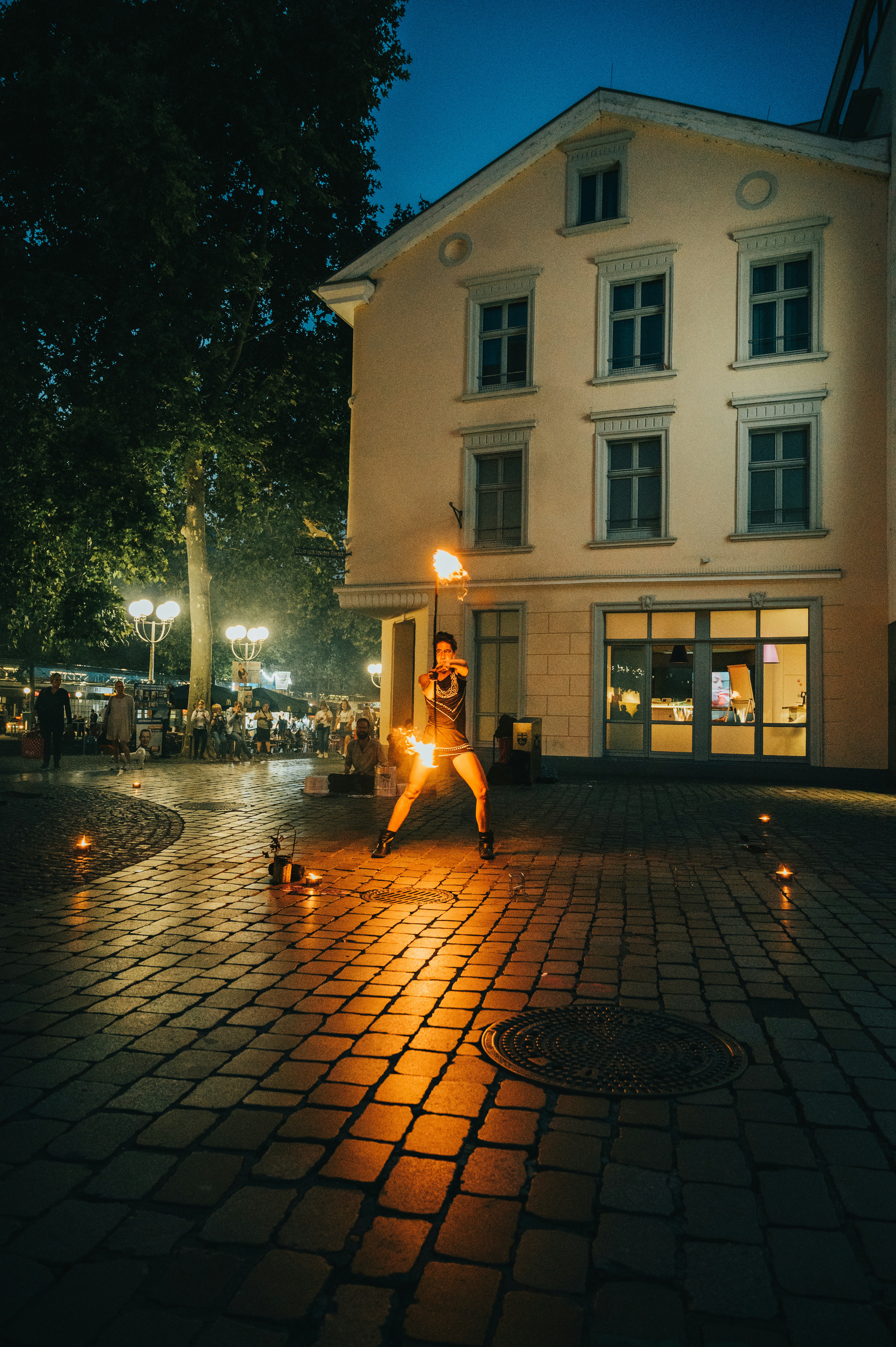 Cobbled Nightfire: Fire Dancer in the Town Square