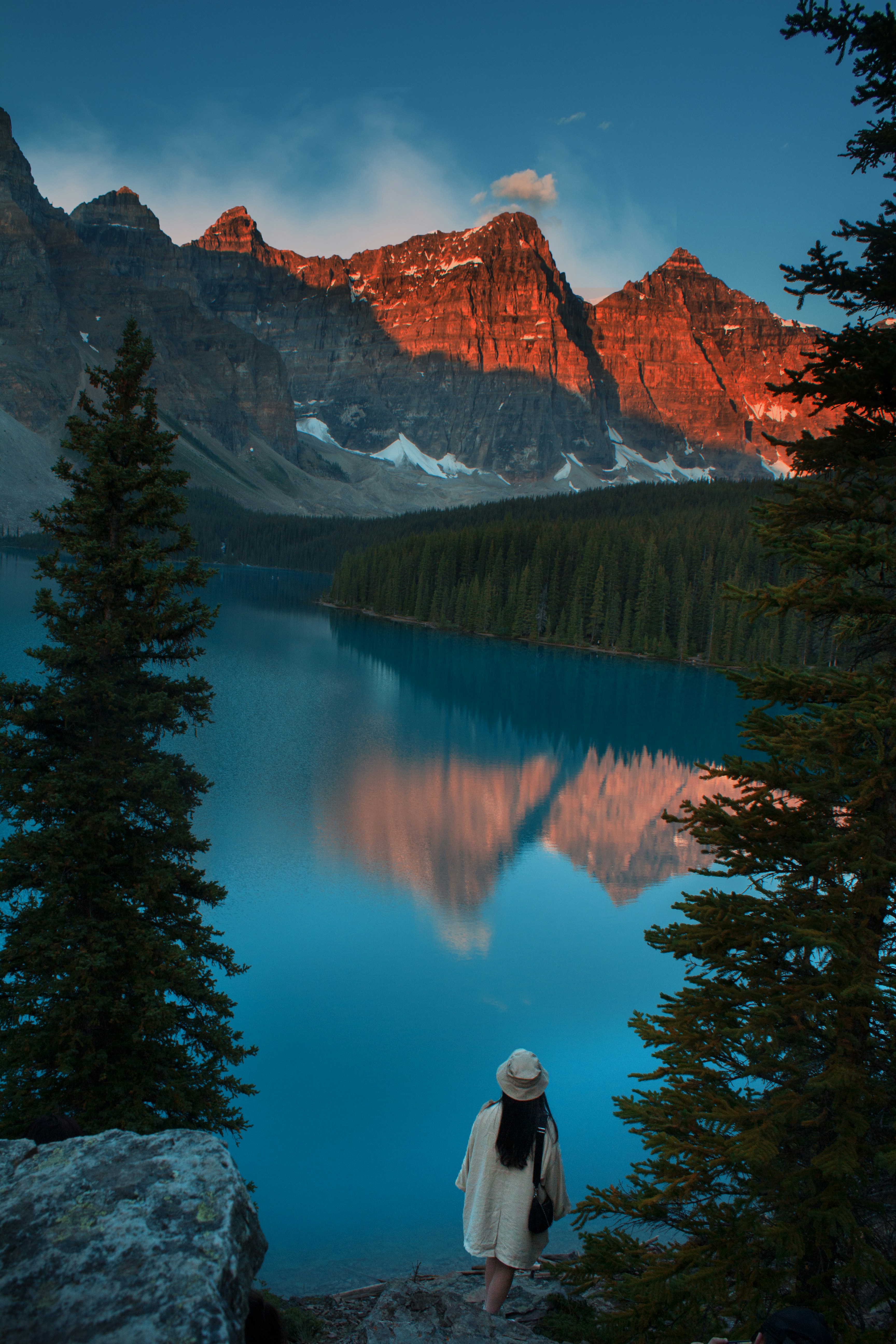 Mountains in a crystalline dawn reflect on a tranquil alpine lake