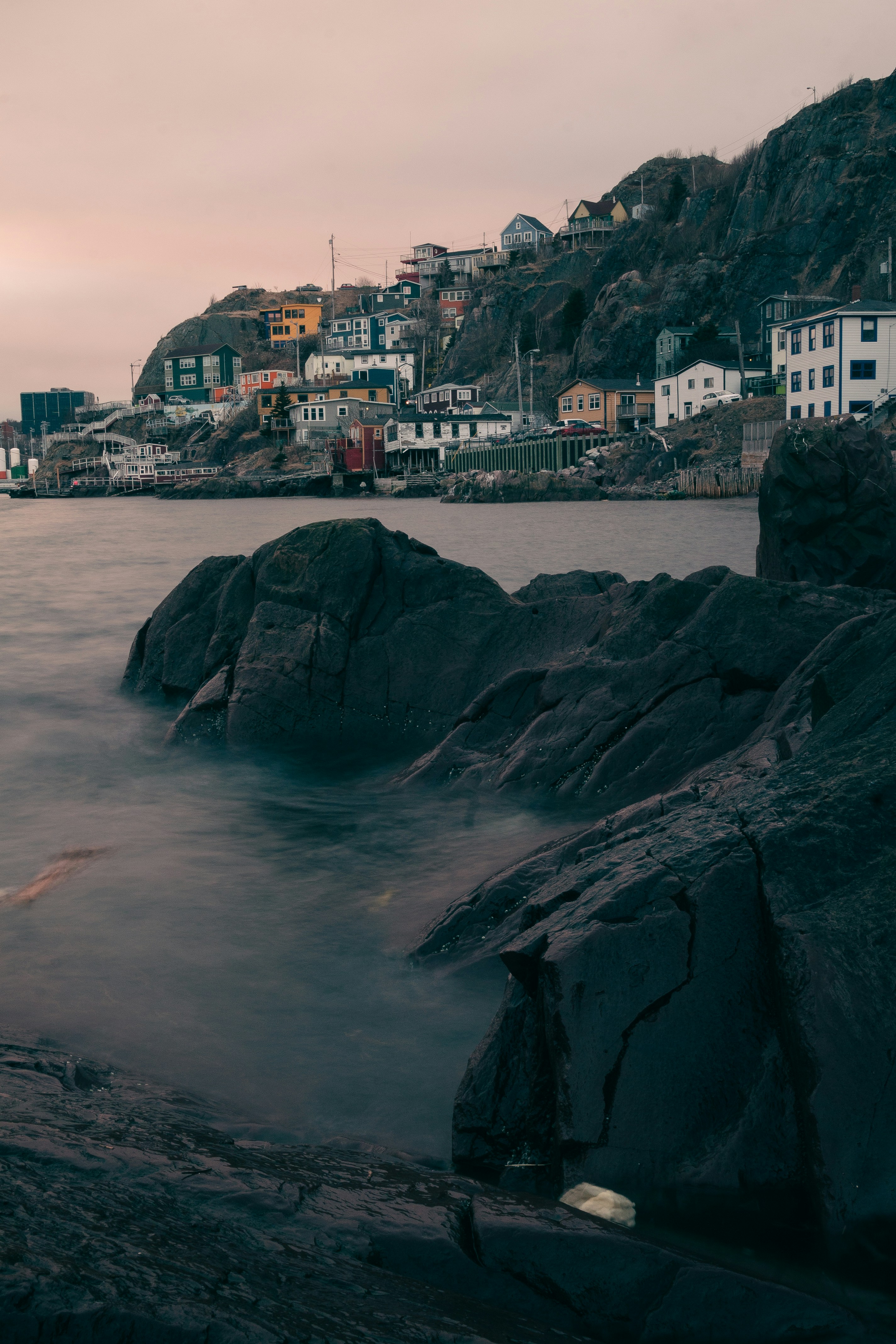 White and red building on rock formation near sea during daytime photo ...
