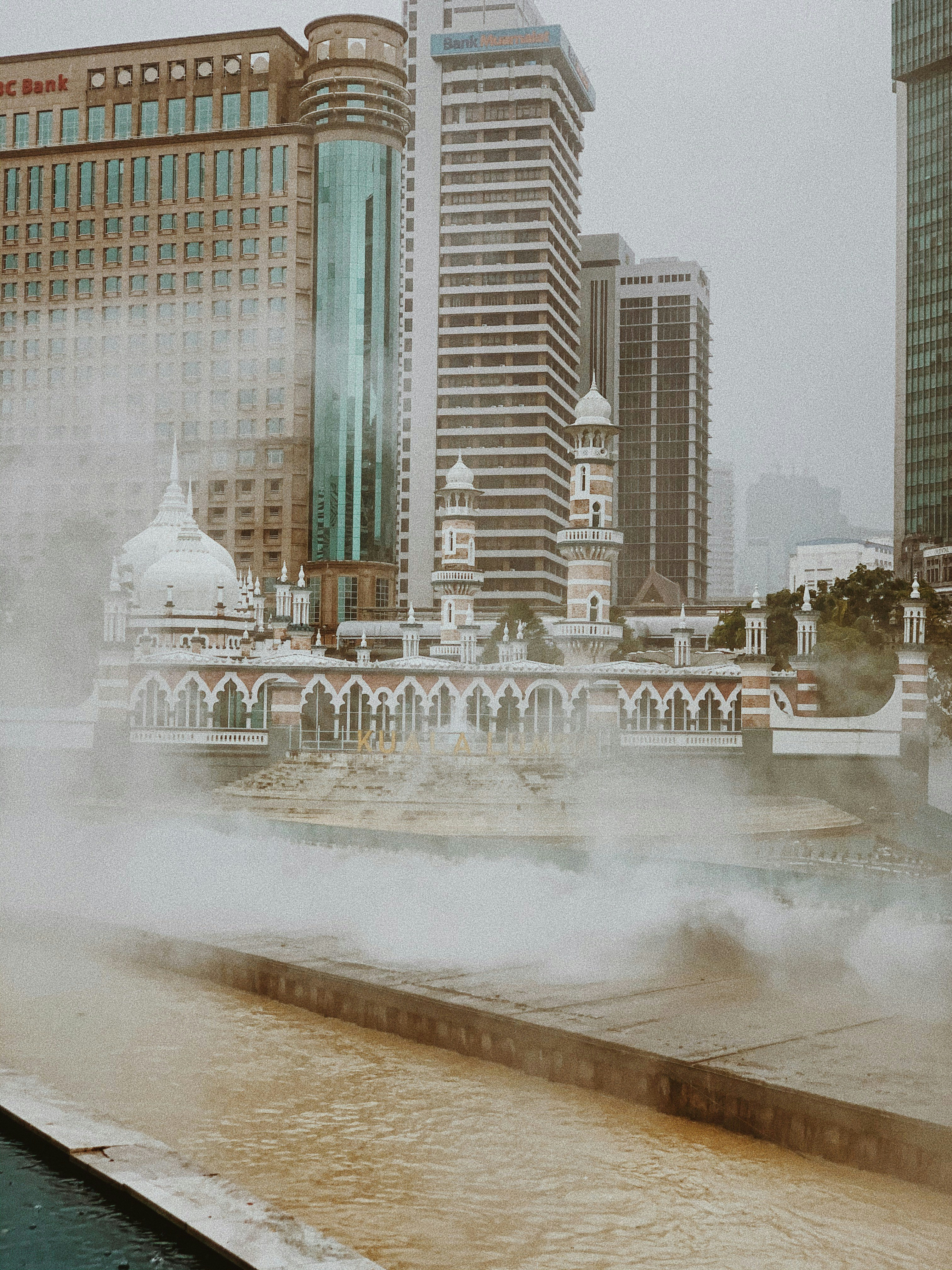 water fountain near high rise buildings during daytime