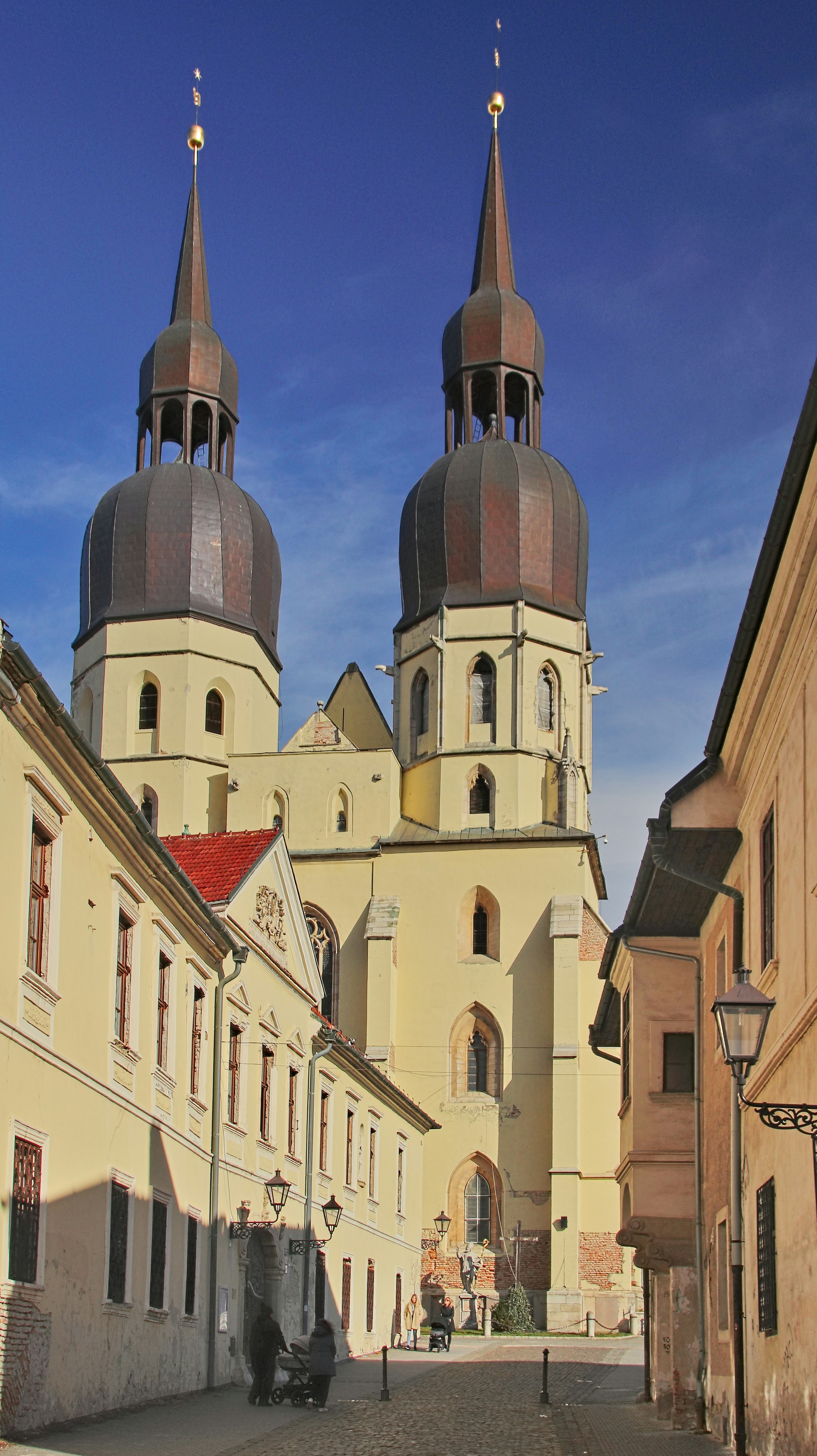 Twin Spires Over a Sunlit European Alley