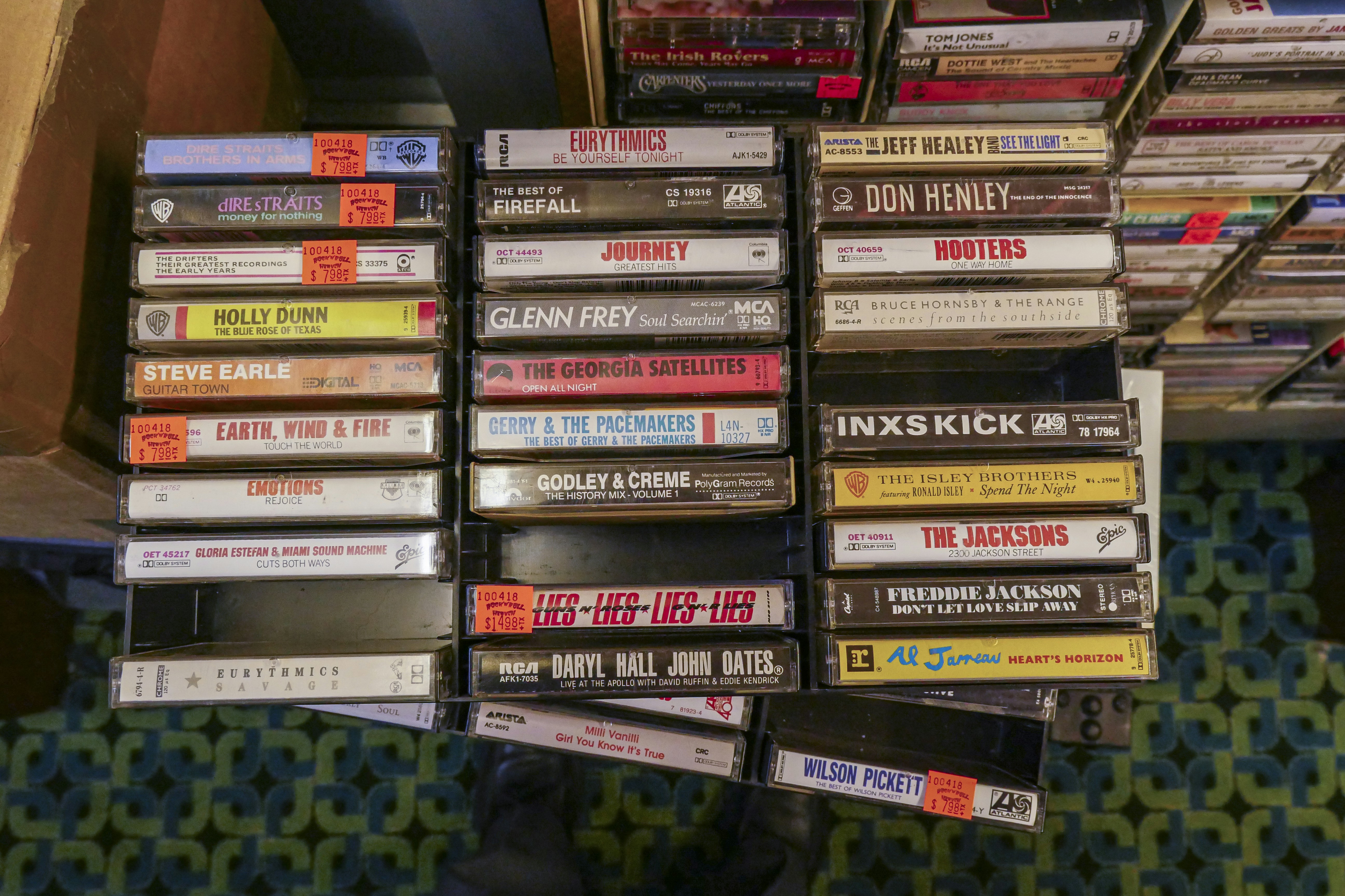 Color-Coded Cassette Archive on a Cozy Shelf