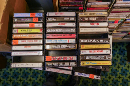 Color-Coded Cassette Archive on a Cozy Shelf