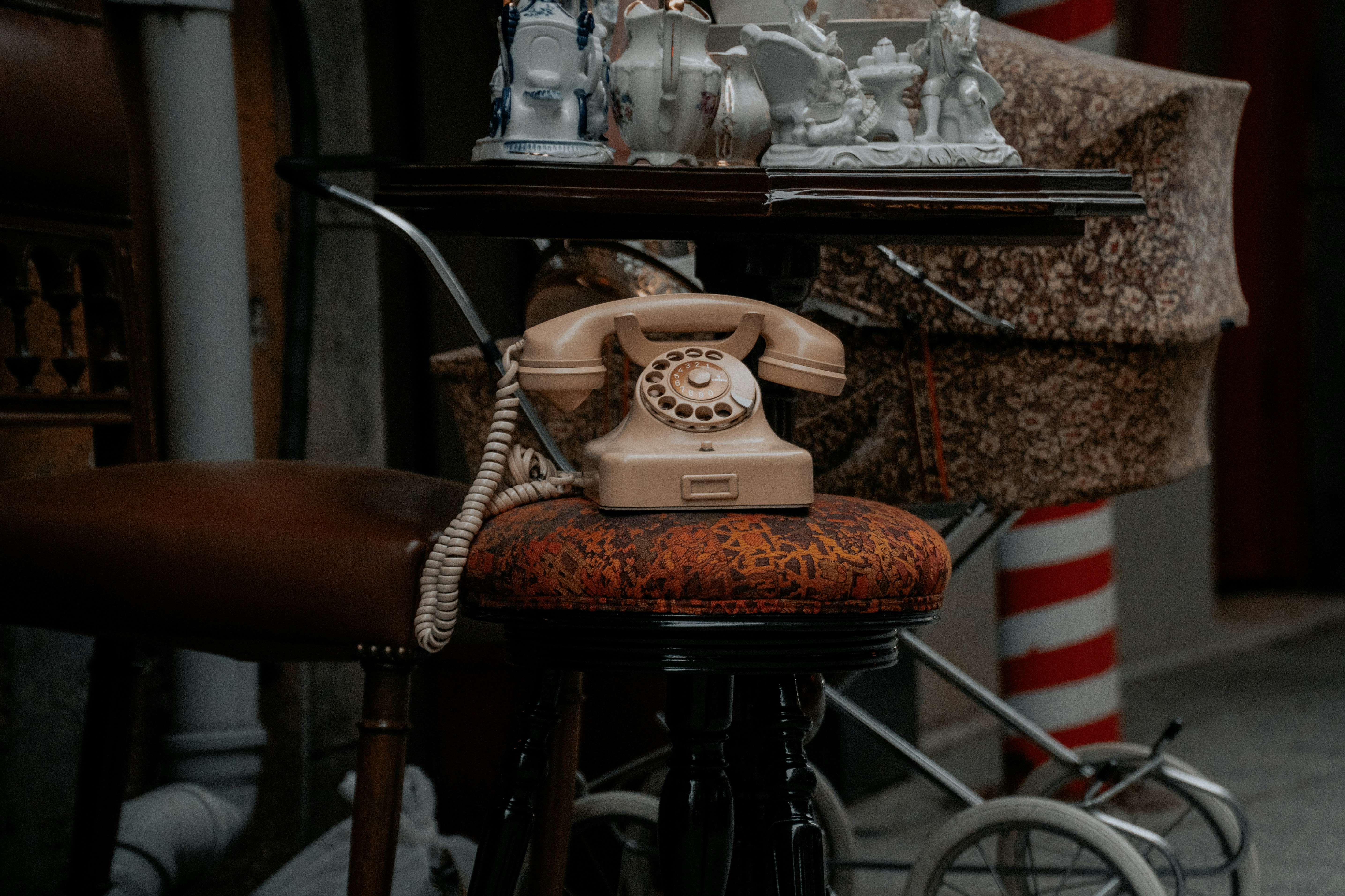Whisper Dial in a Dim Studio: Vintage Rotary Phone Beside a Chess Set