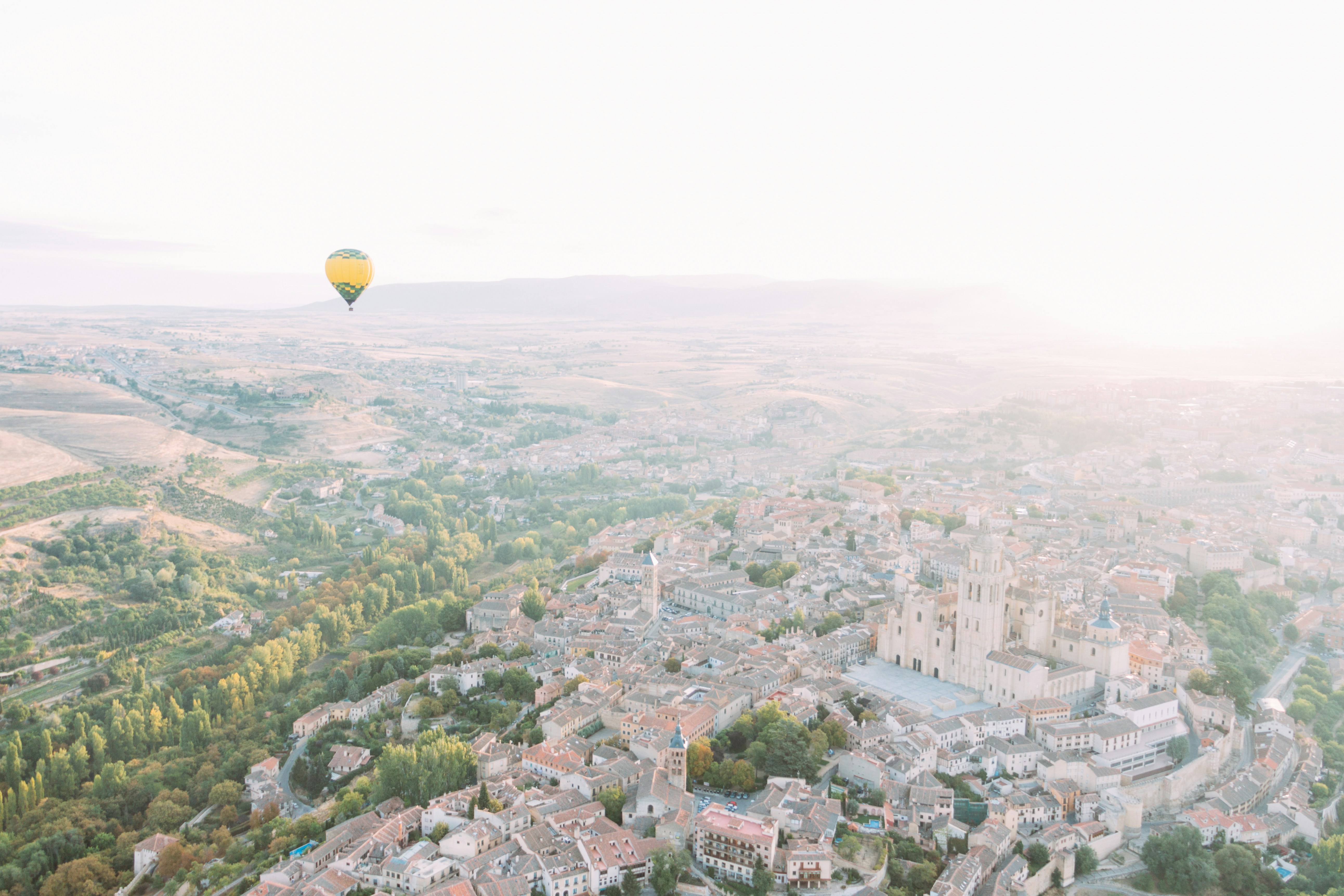 Balloon Drift Above a Sunlit European Town at Dawn