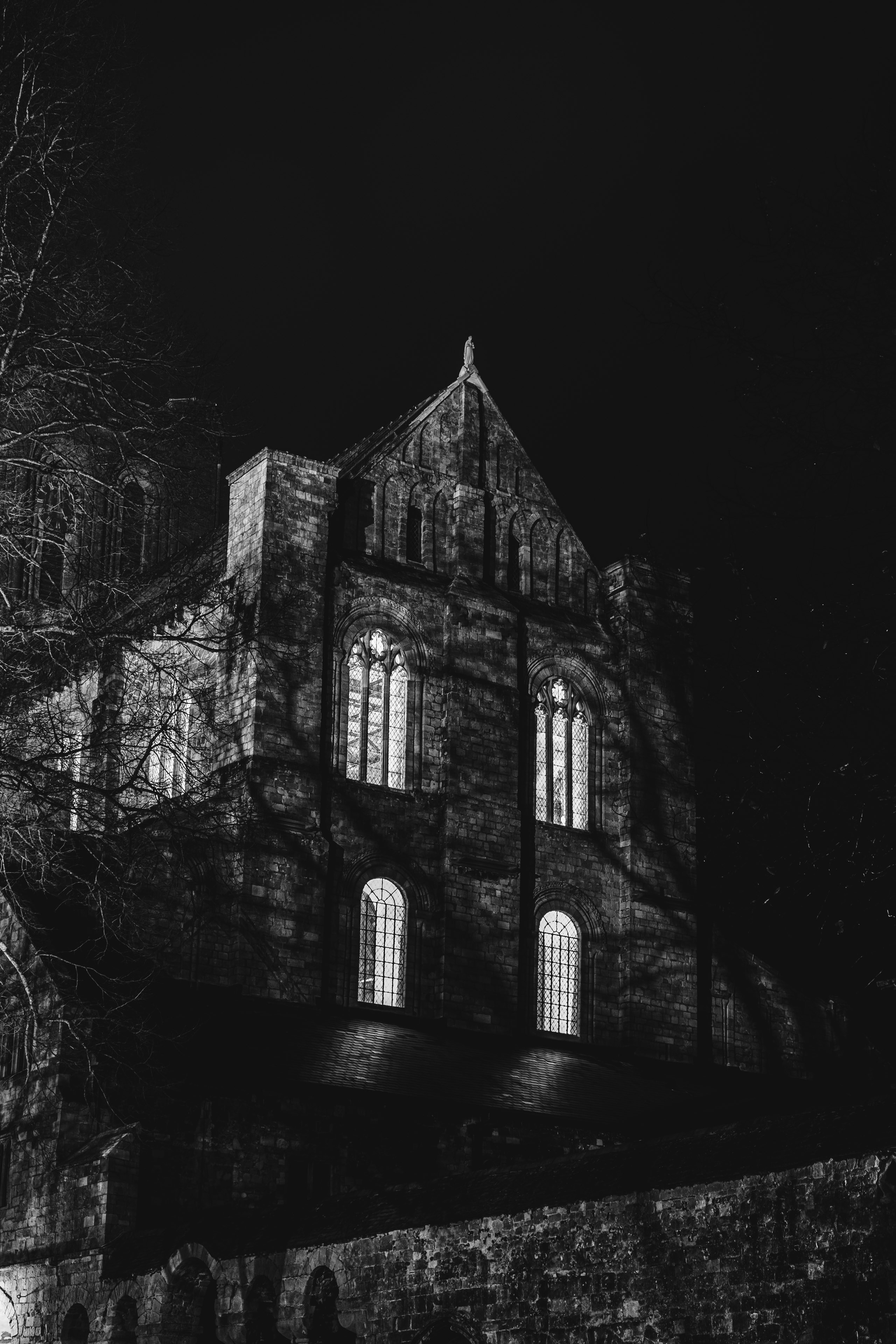 Moonlit Ruins: Gothic Facade Emerges from Night
