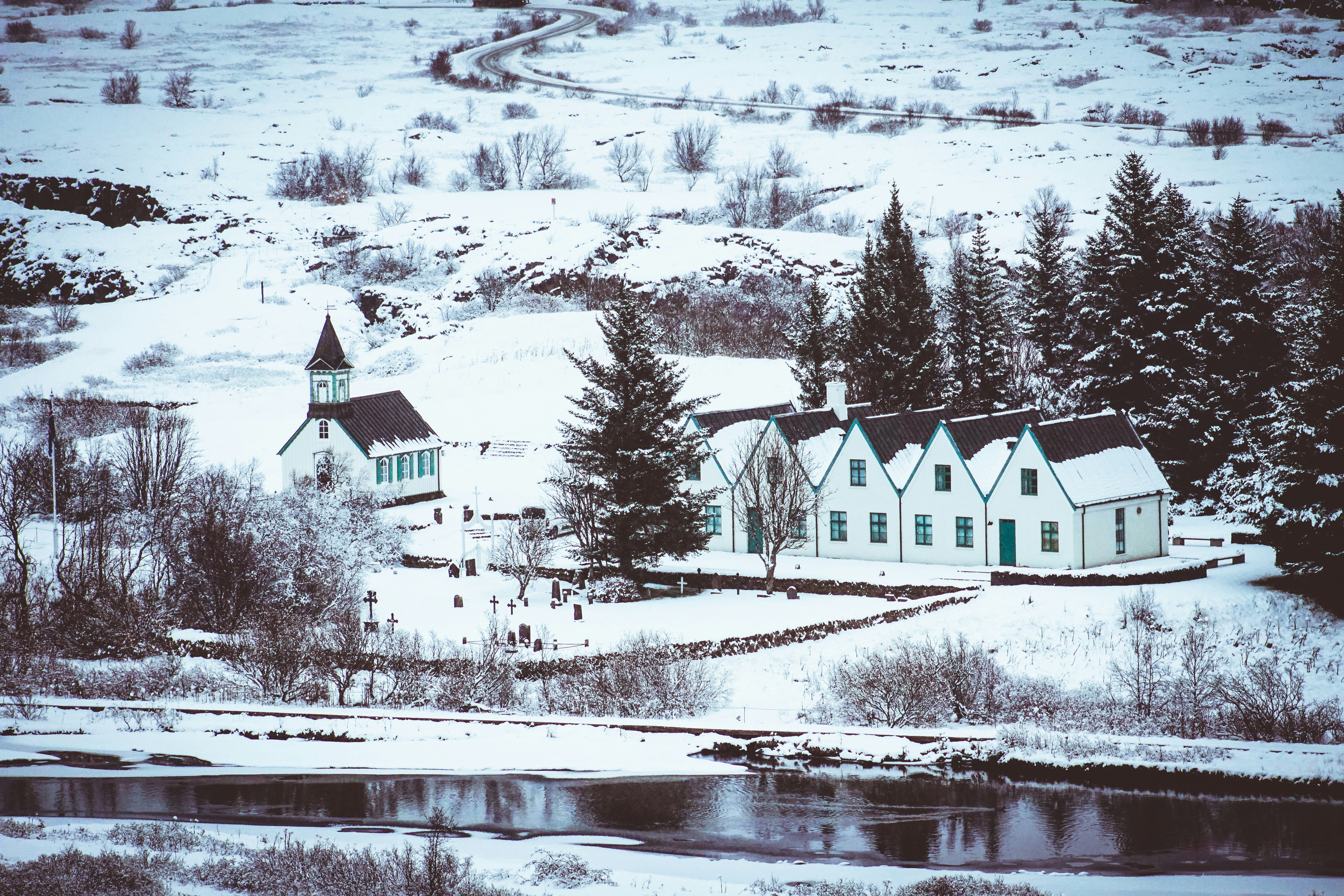 Snowbound Village: A Frost-Blue Churchfront Beside a Quiet River