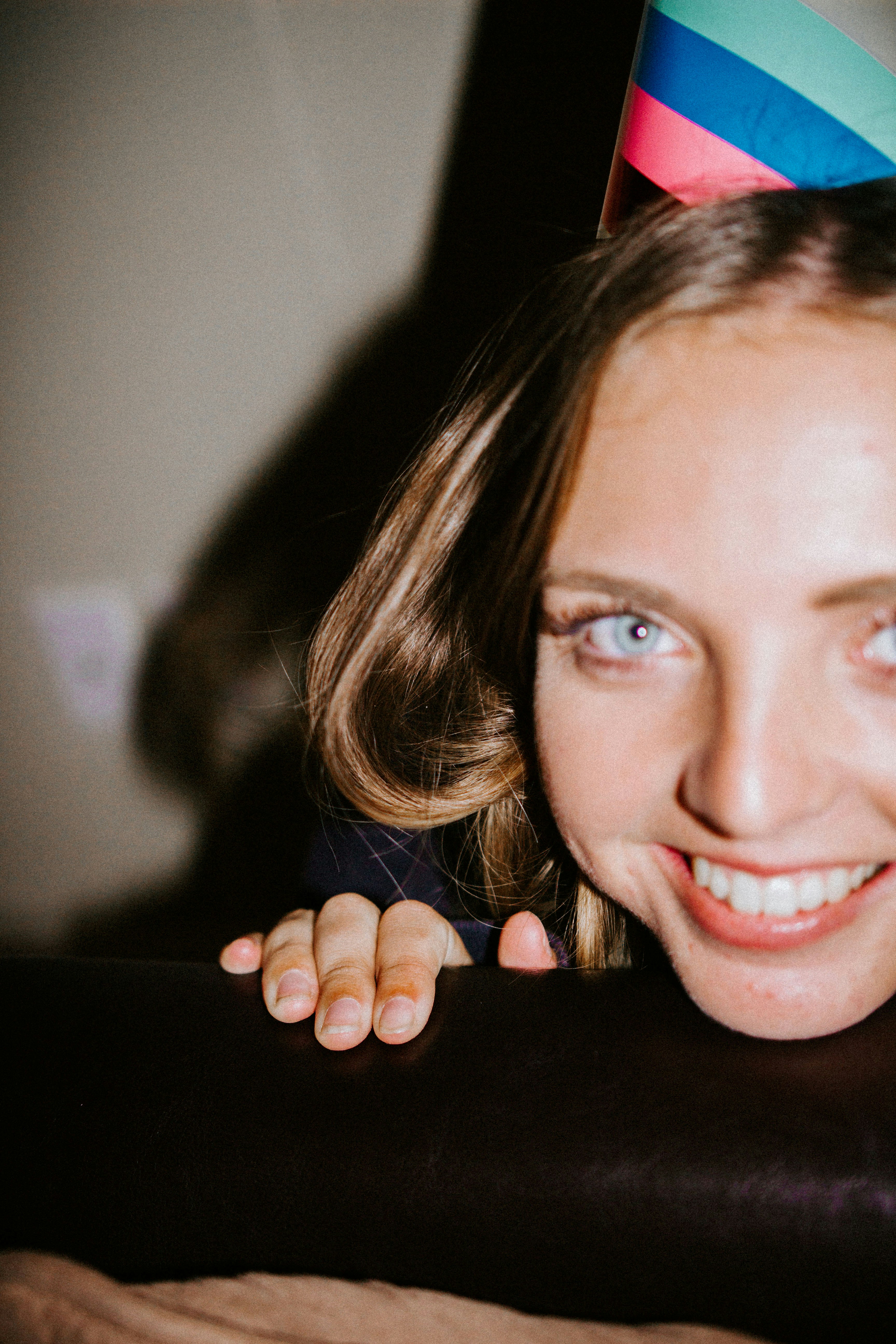 Party Hat Peeking: A Cheerful Smile from the Edge of the Frame