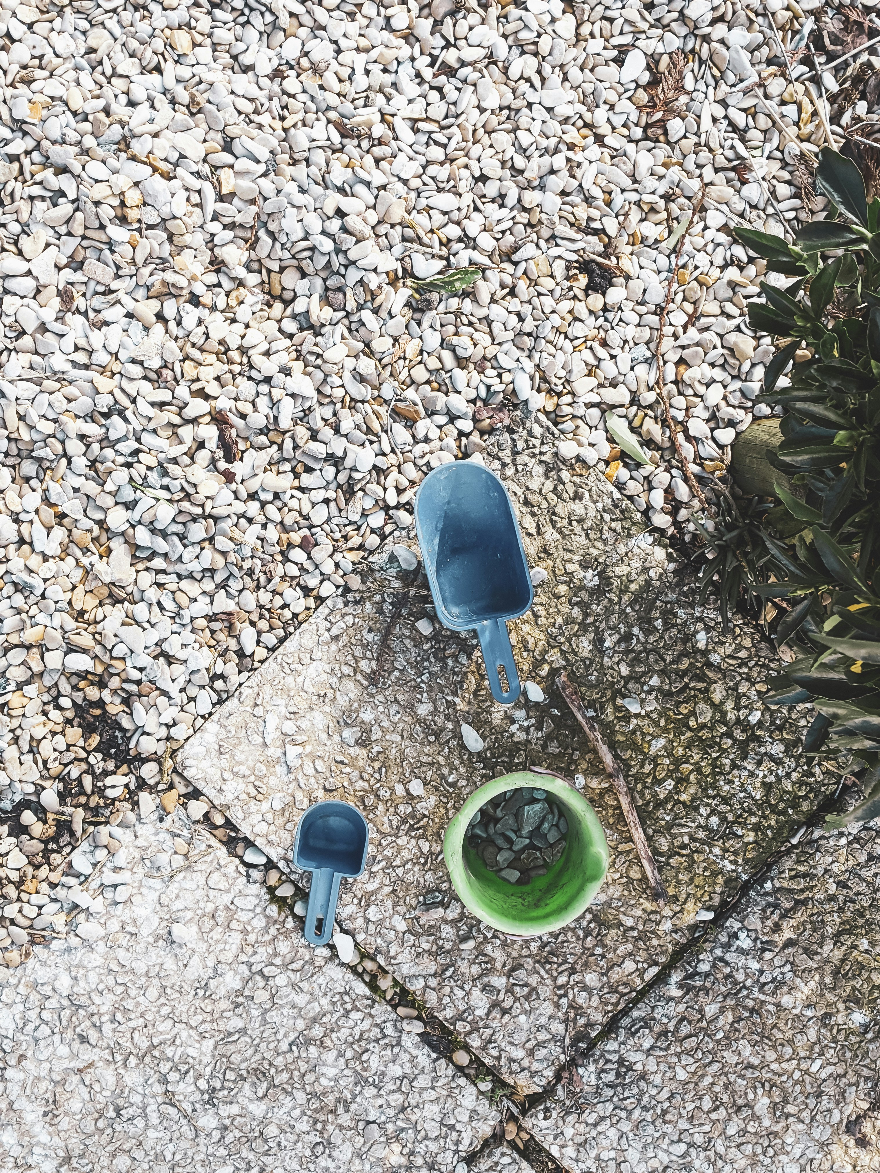 Tools on Concrete Slab: A Top-Down Playground of Pebbles and Pots