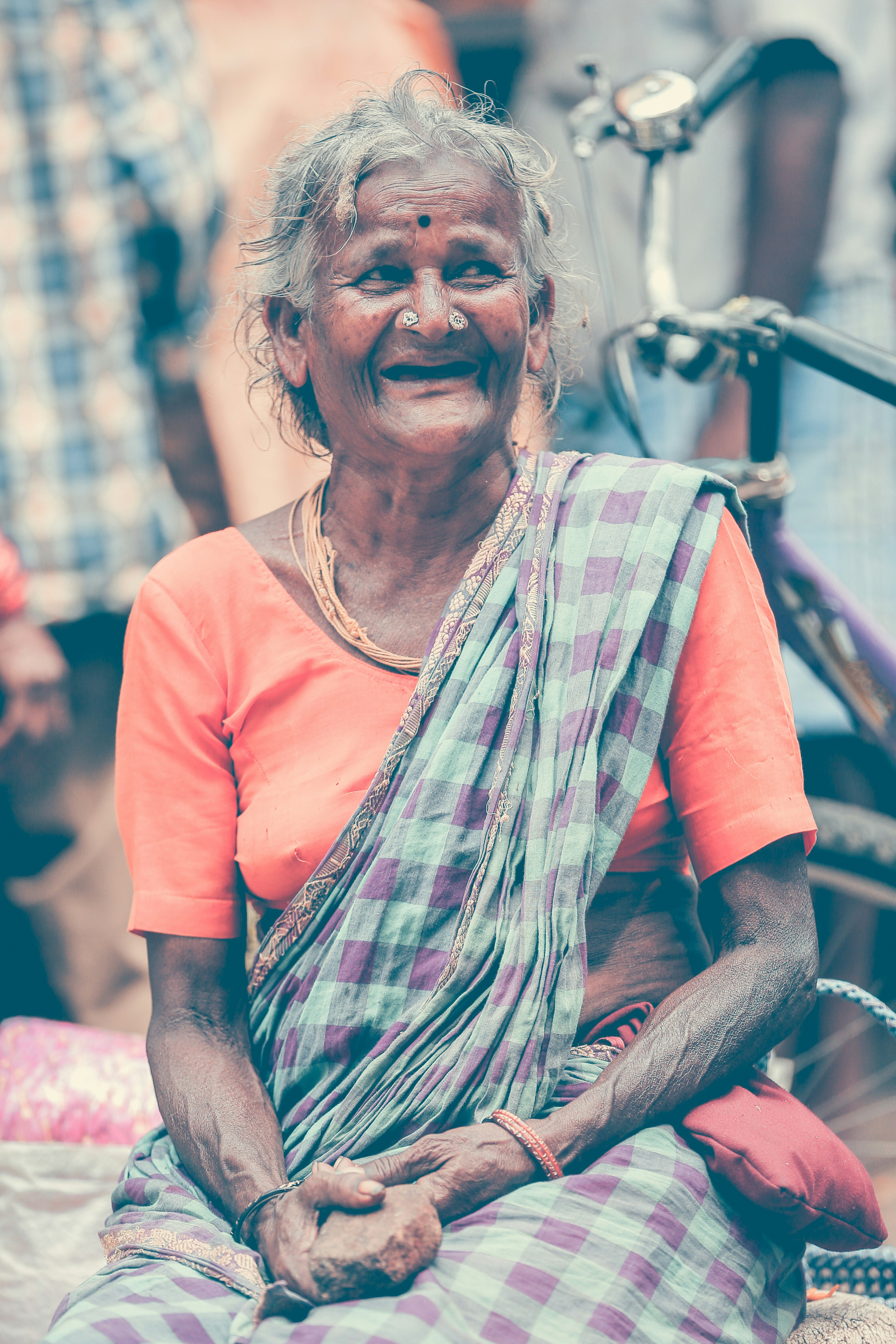 Smile Across the Street: Elder Woman in Orange and Plaid Sari