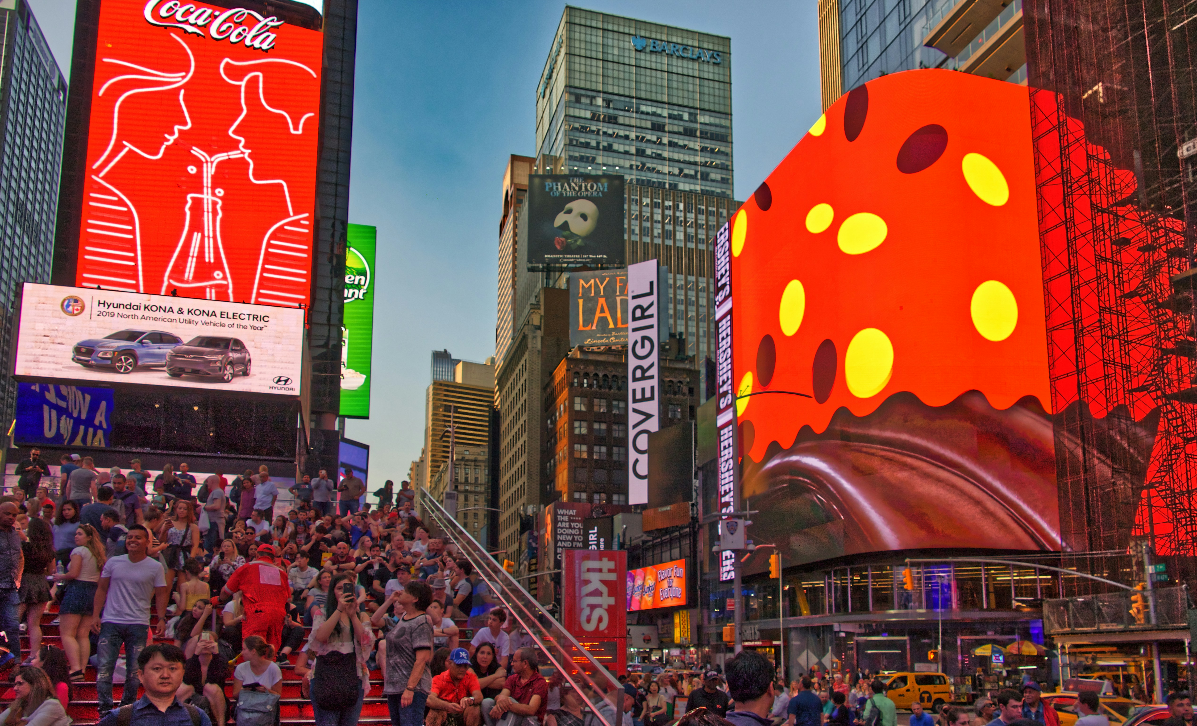 Neon Confluence on Broadway: Crowds, Coca-Cola Glow, and Giant Screens