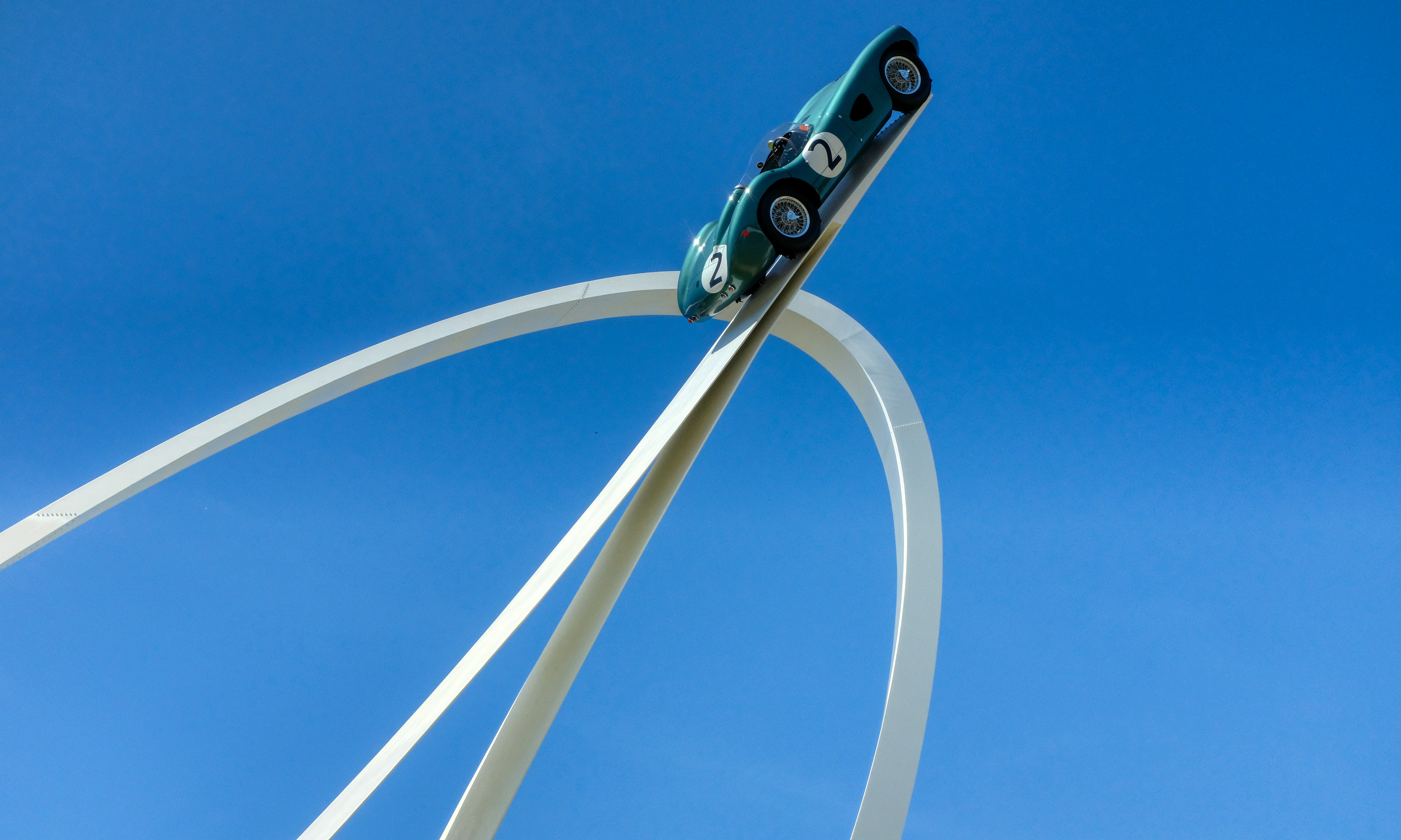 Teal Coupe Balances on a Skyward Arch