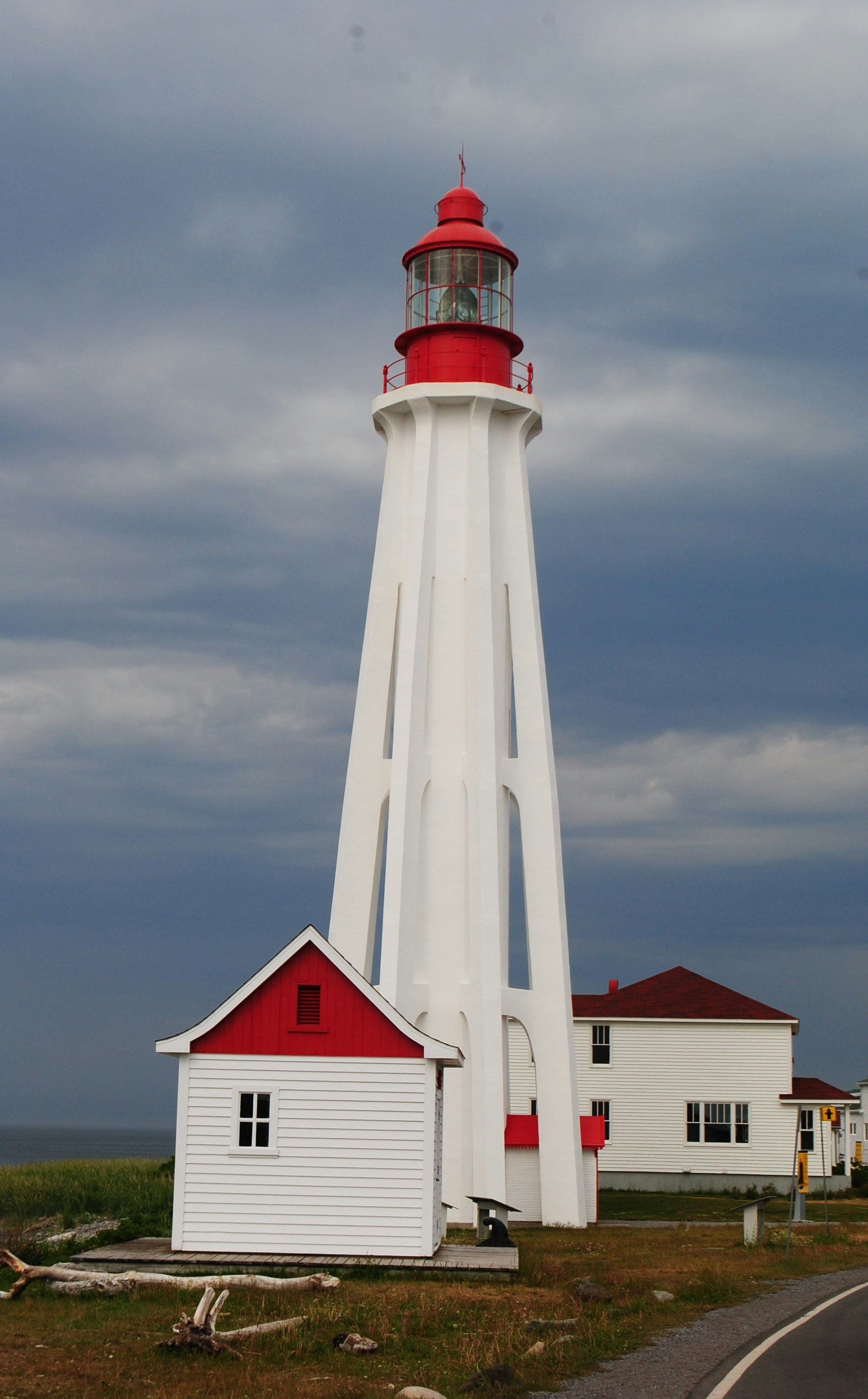 White and red lighthouse under cloudy sky during daytime photo – Free ...