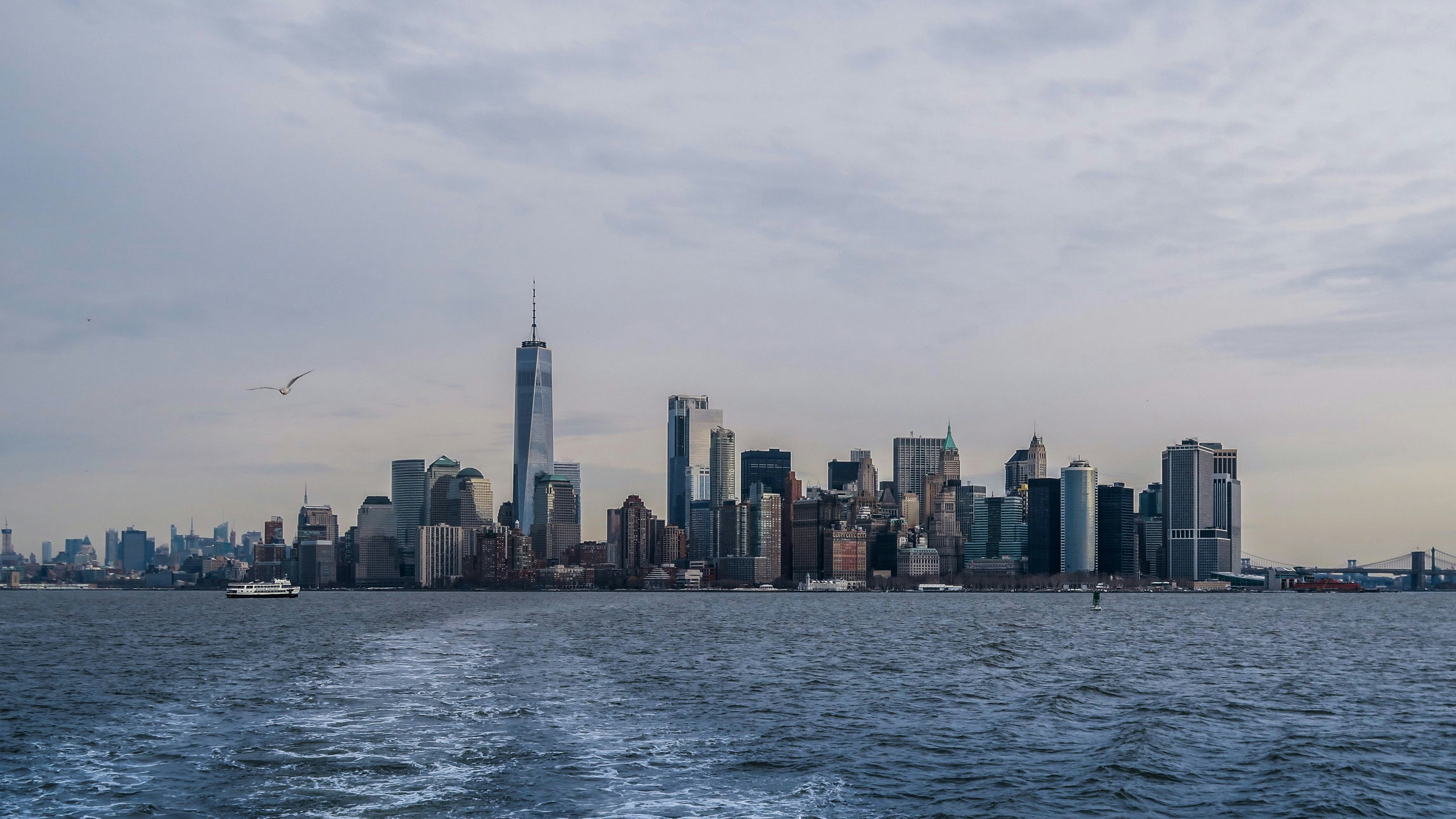 A panoramic view of a bustling city skyline from the water, showcasing a blend of modern architecture and the serene movement of the waves.