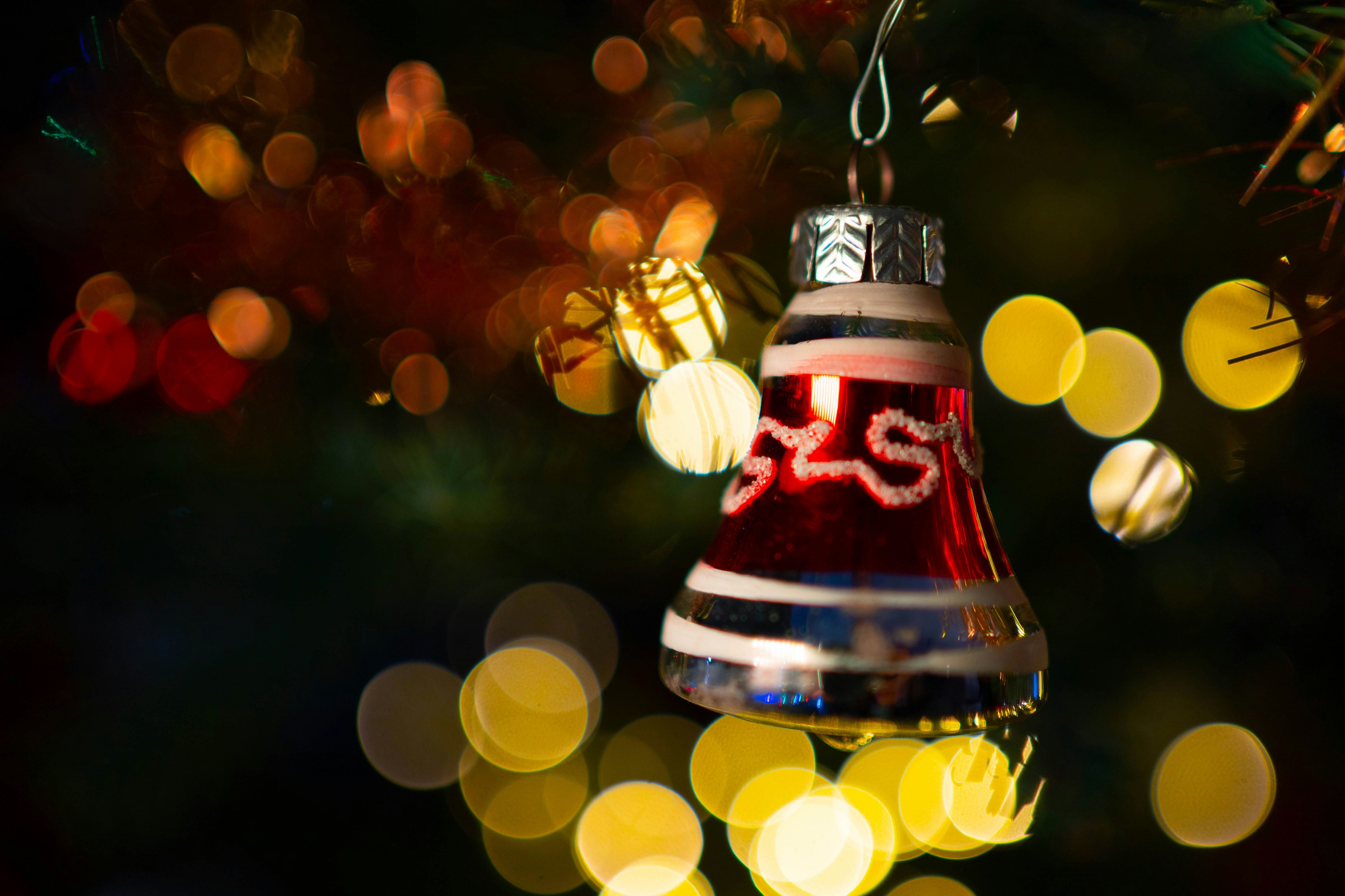 Glinting Bell Amid Golden Orbs: A Christmas Moment