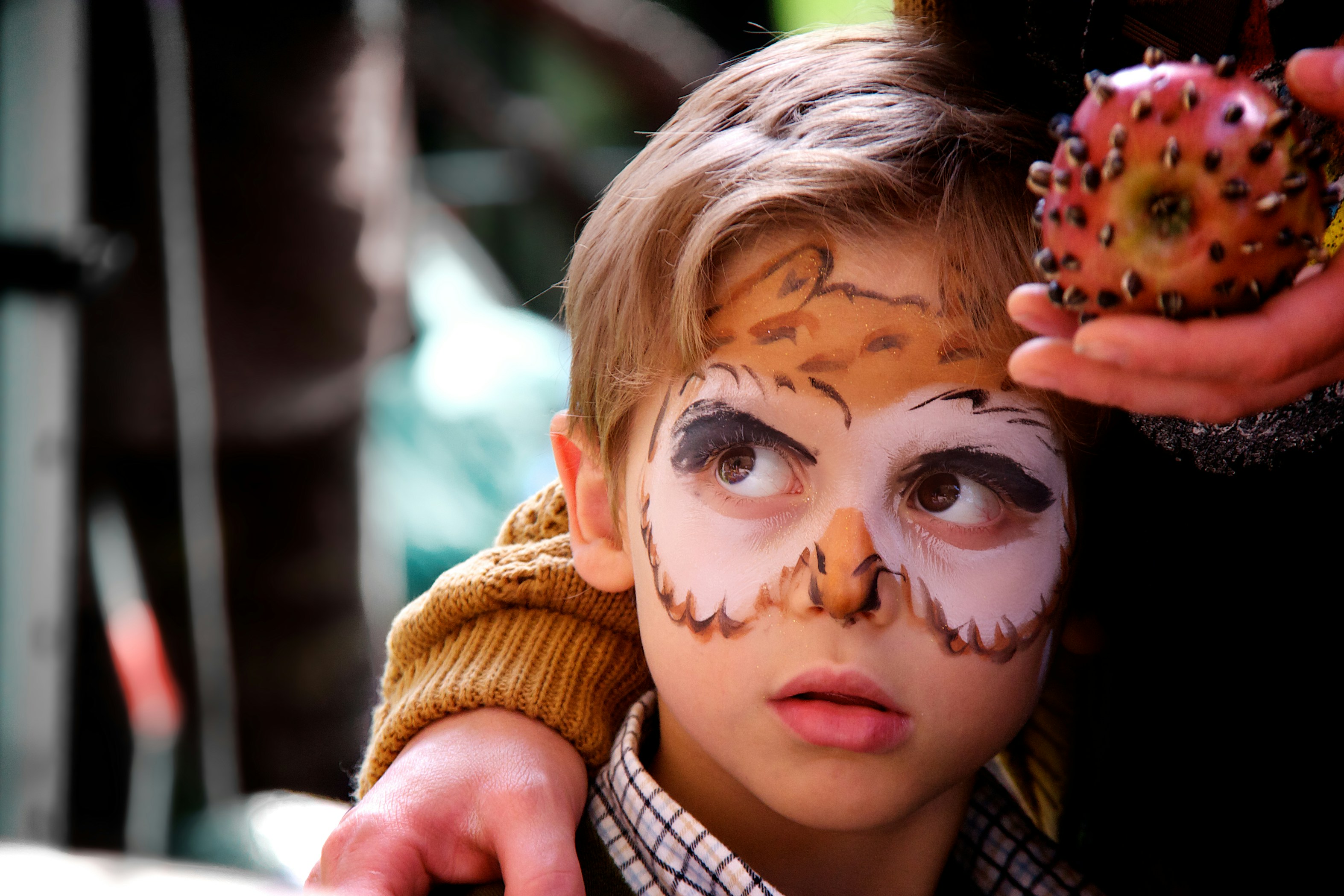 Face Painted as a Fox Tagging a Moment with a Strawberry Glimpse