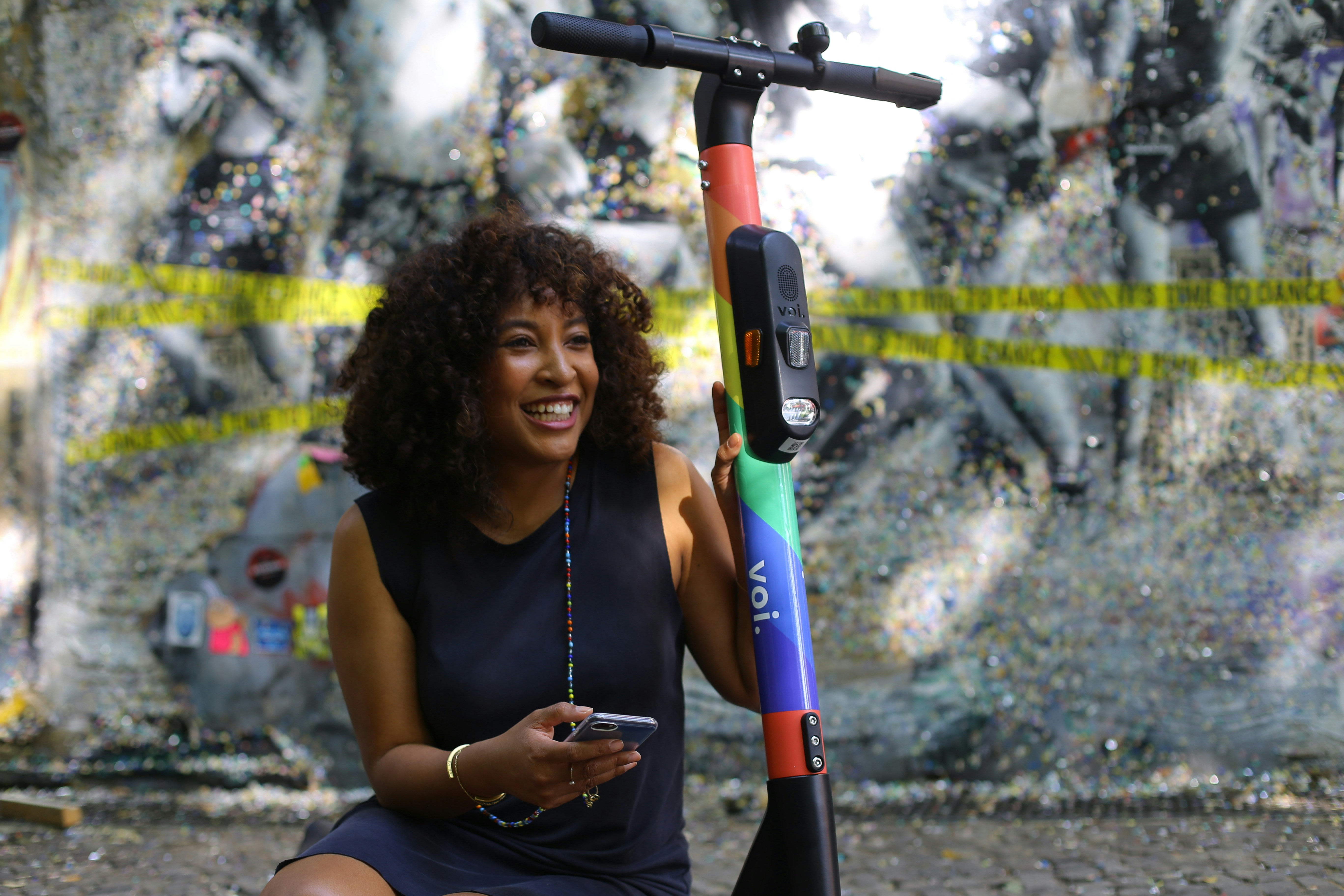 Smiling moment with a colorful kick scooter