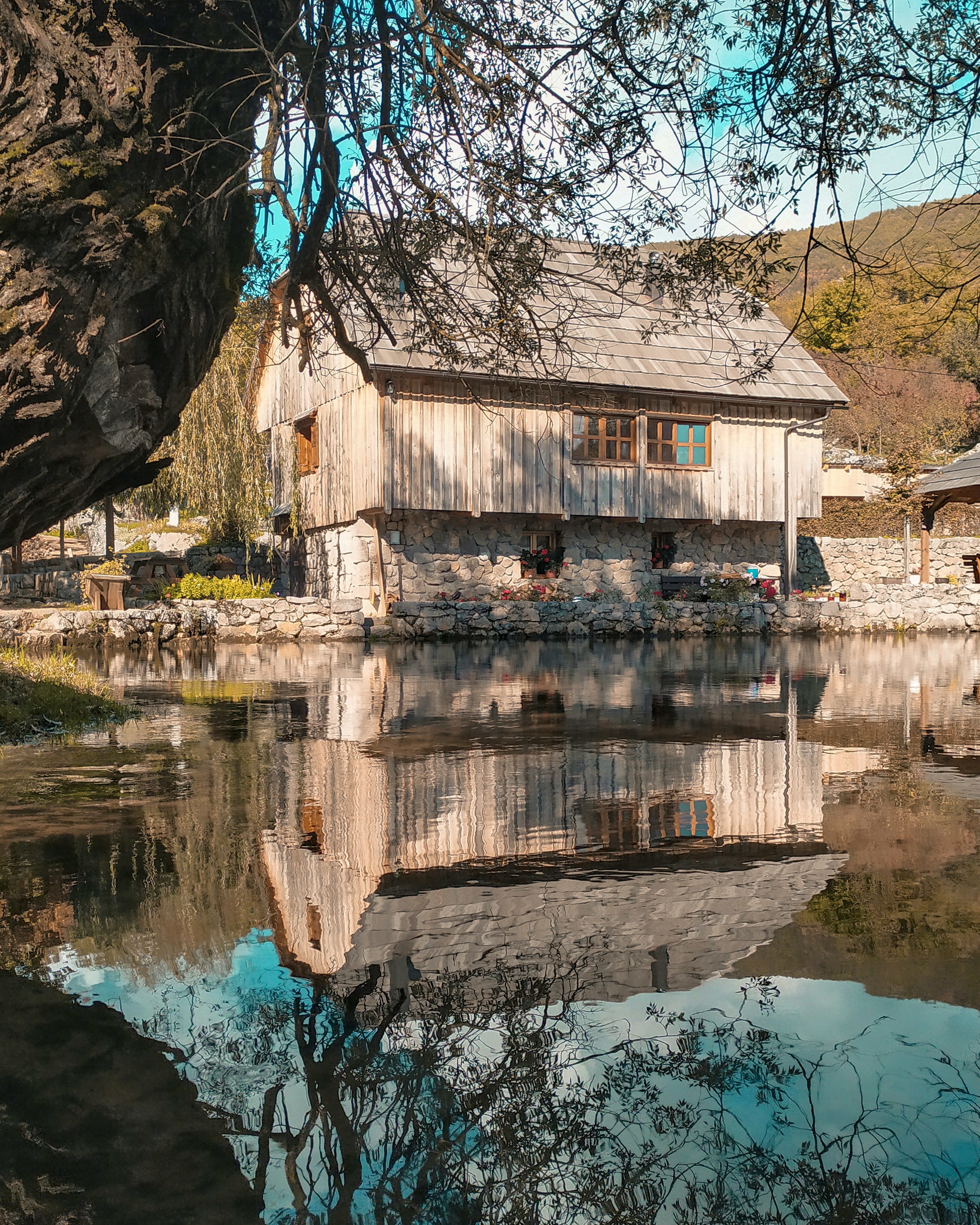 Timber Boathouse and Its Silent Mirror on a Mountain Lake