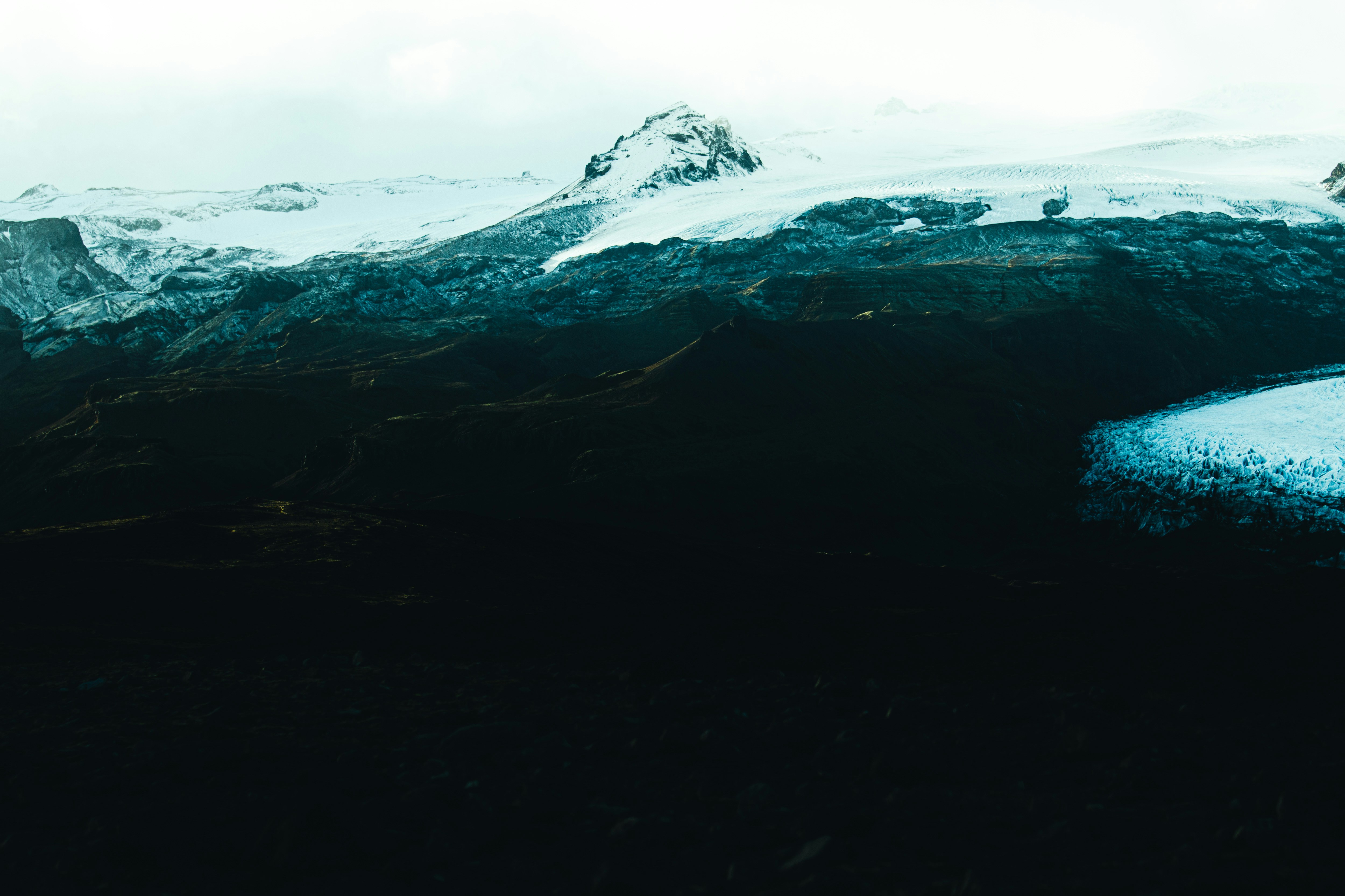 Icebound Ridge at Dusk: A Sharp Horizon Above Silent Basalt