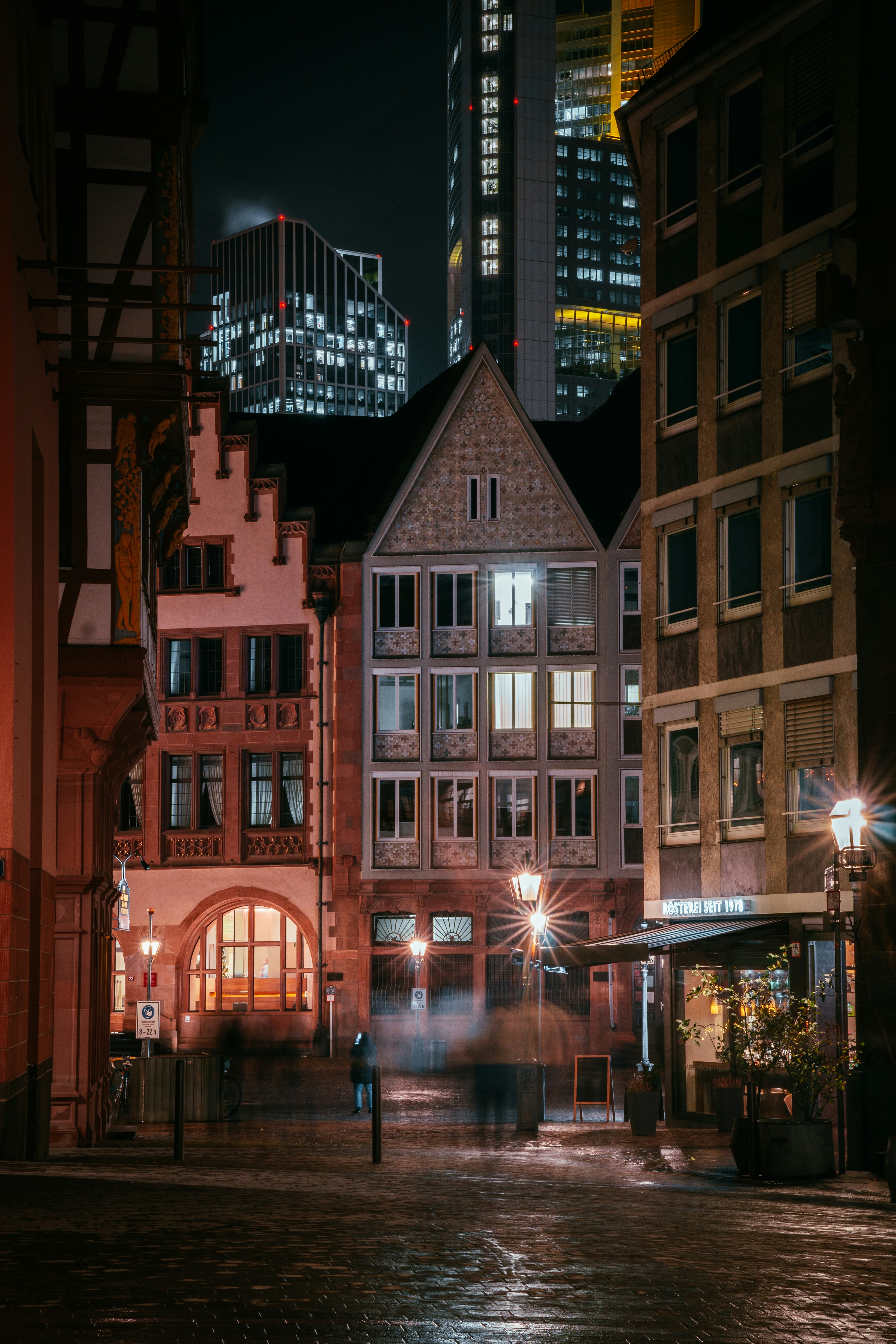 Midnight Facades: Historic Gables Meet Glass Giants