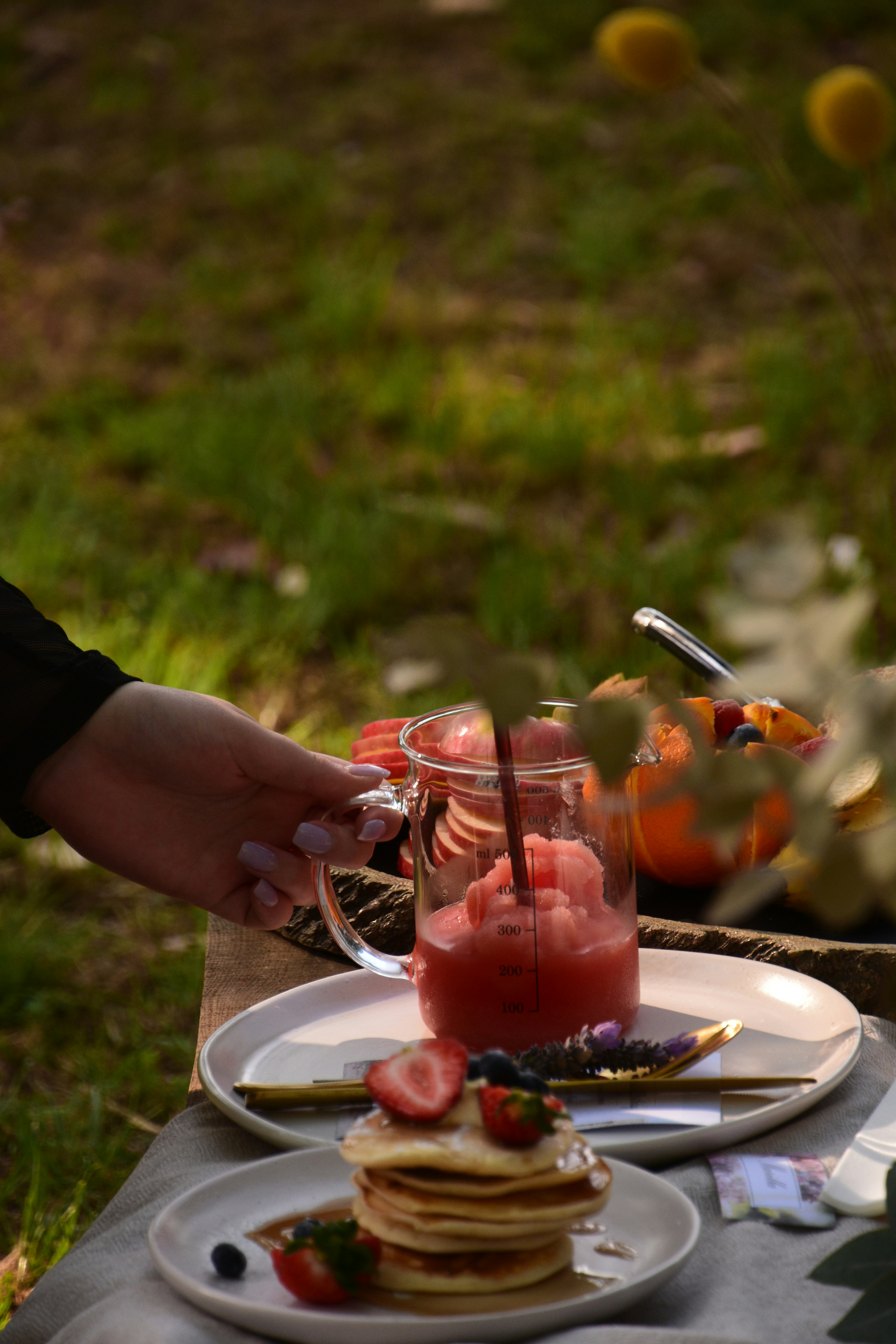 Sunlit Picnic Pour: Pink Lemonade, Pancakes, and Fresh Berries