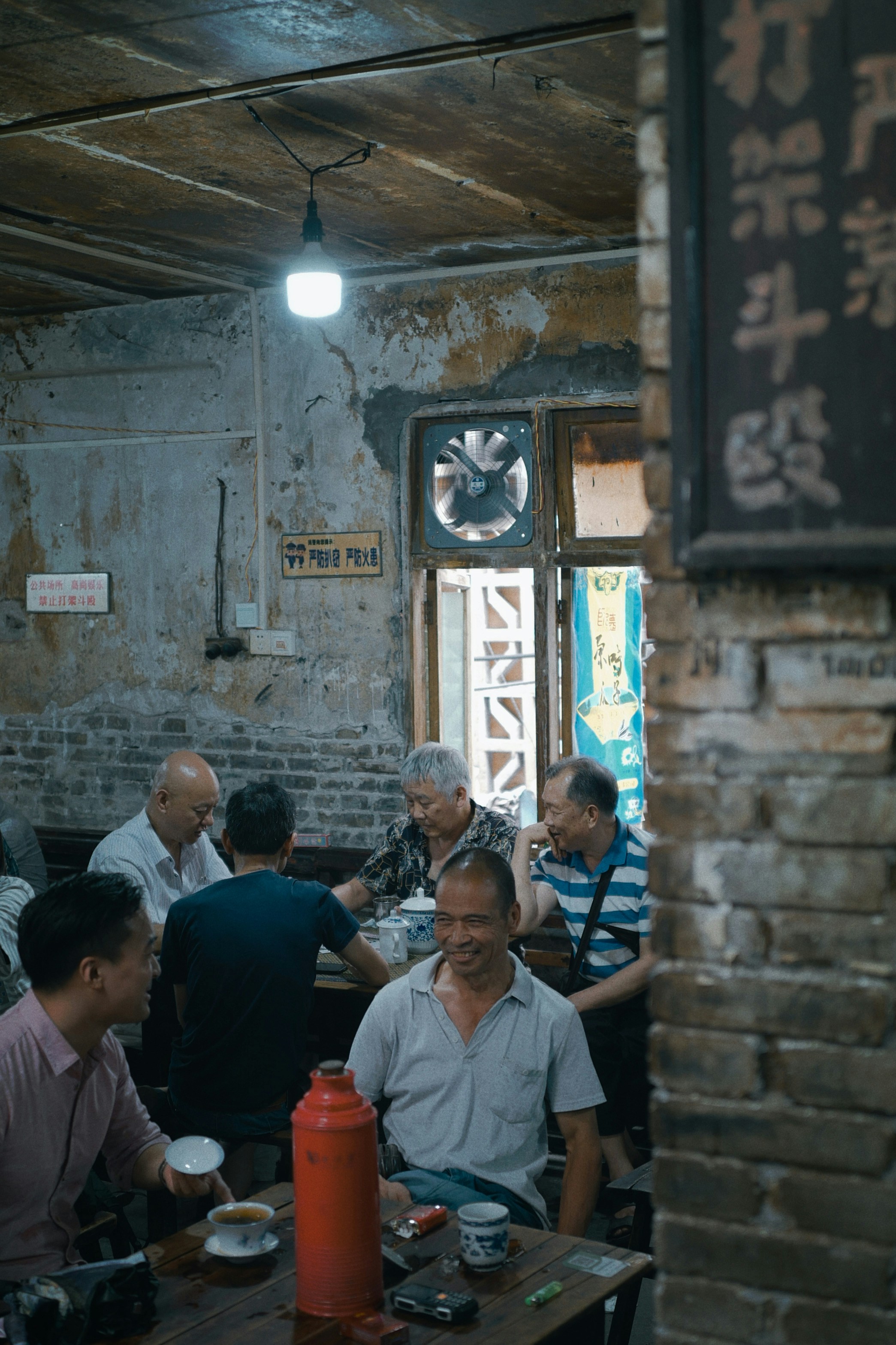 A Quiet Meal under a Bare Bulb in a Weathered Brick Café