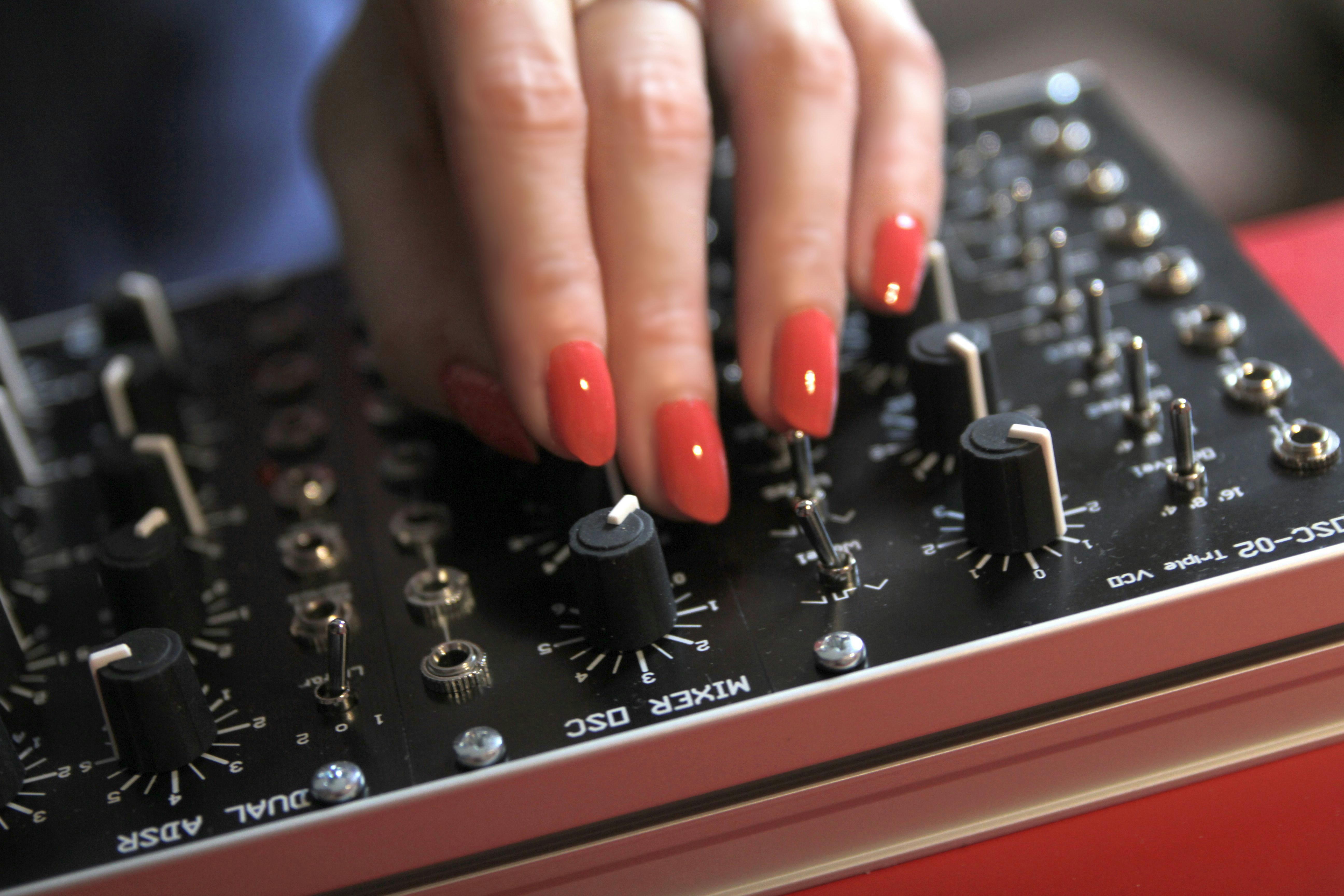Dialing in: fingers glide over a vintage modular mixer