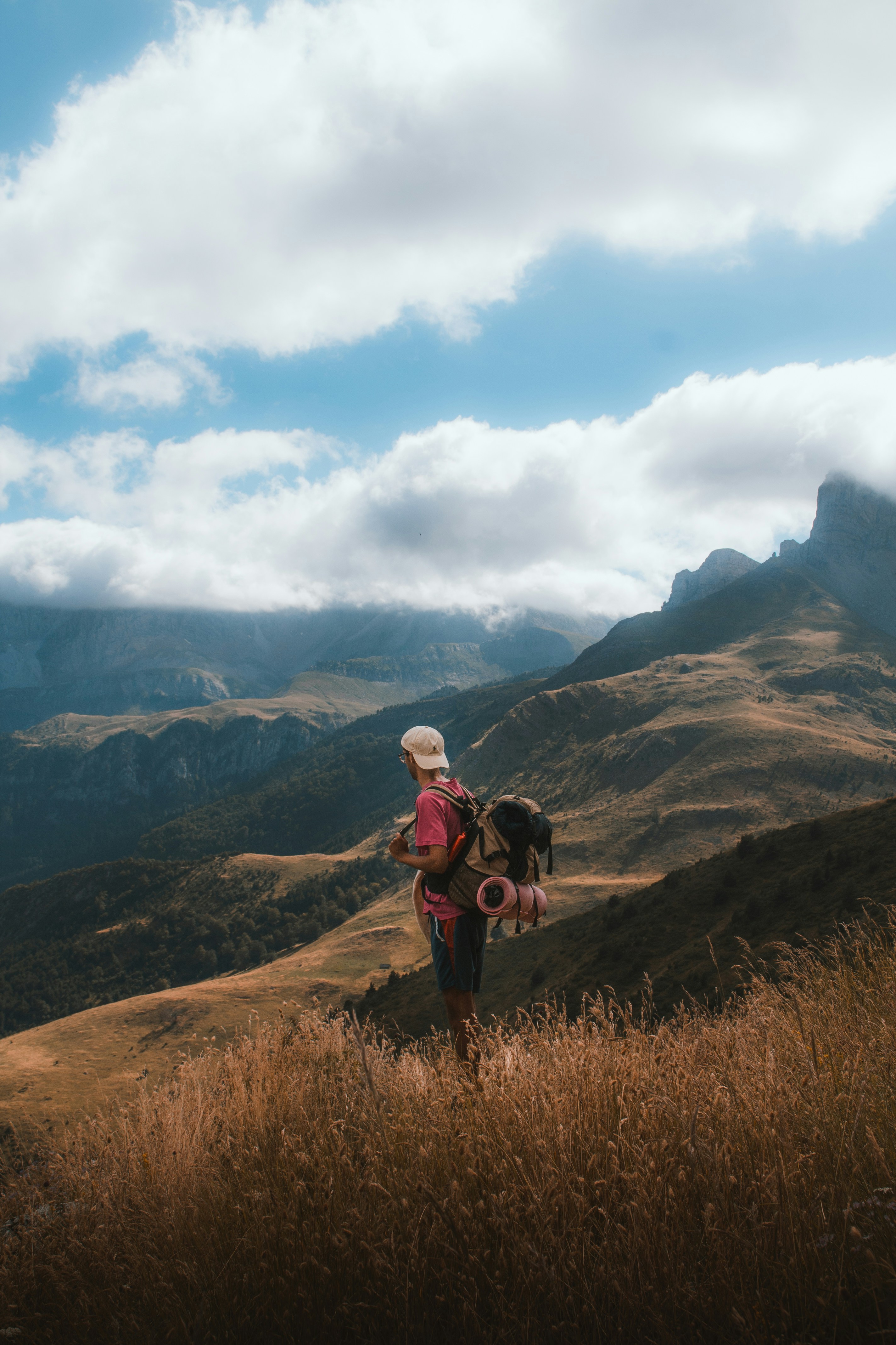 Ridge Stillness: A lone hiker surveys sweeping alpine ridges