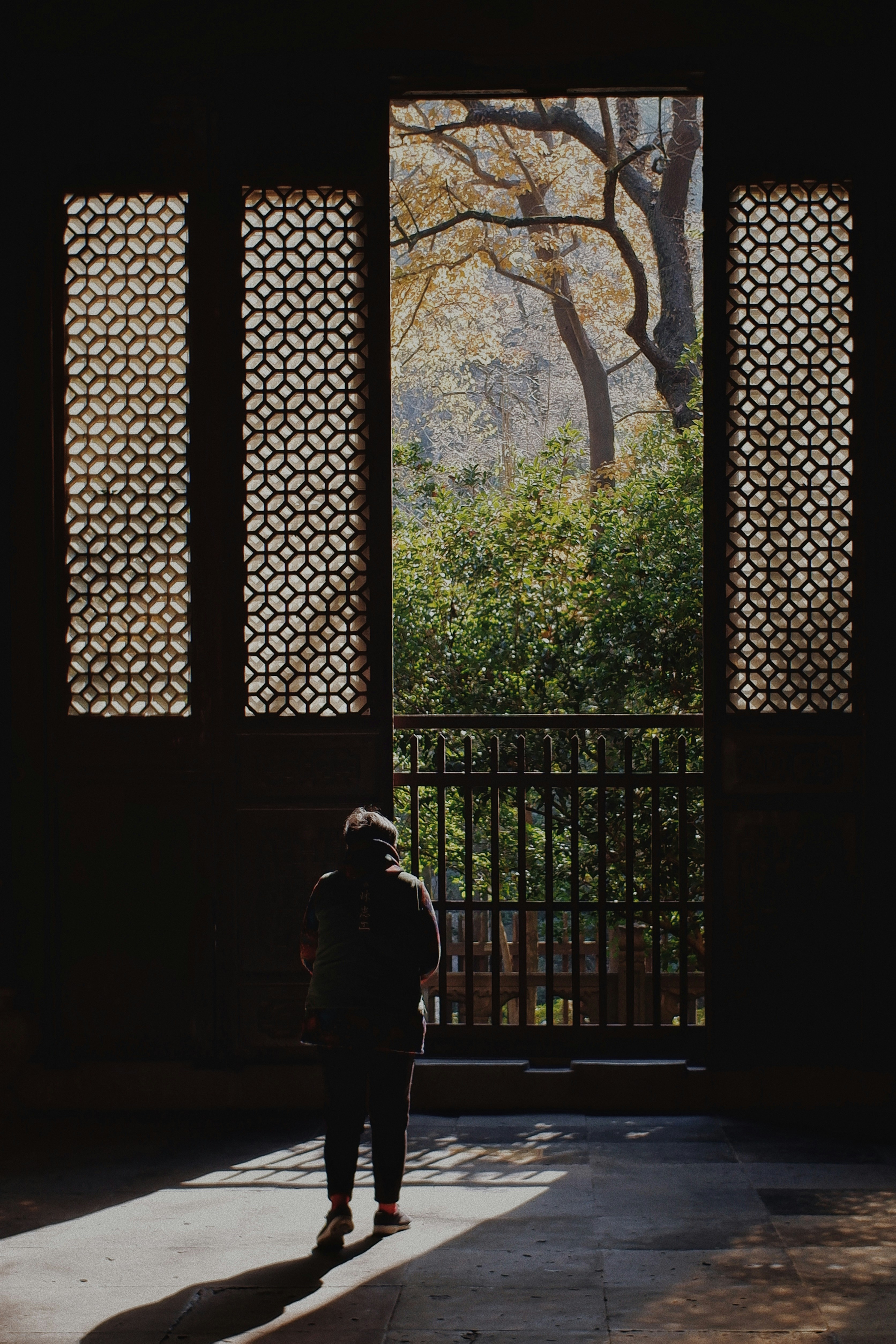 Person in black jacket standing near gate photo – Free 灵隐寺-飞来峰 Image on ...