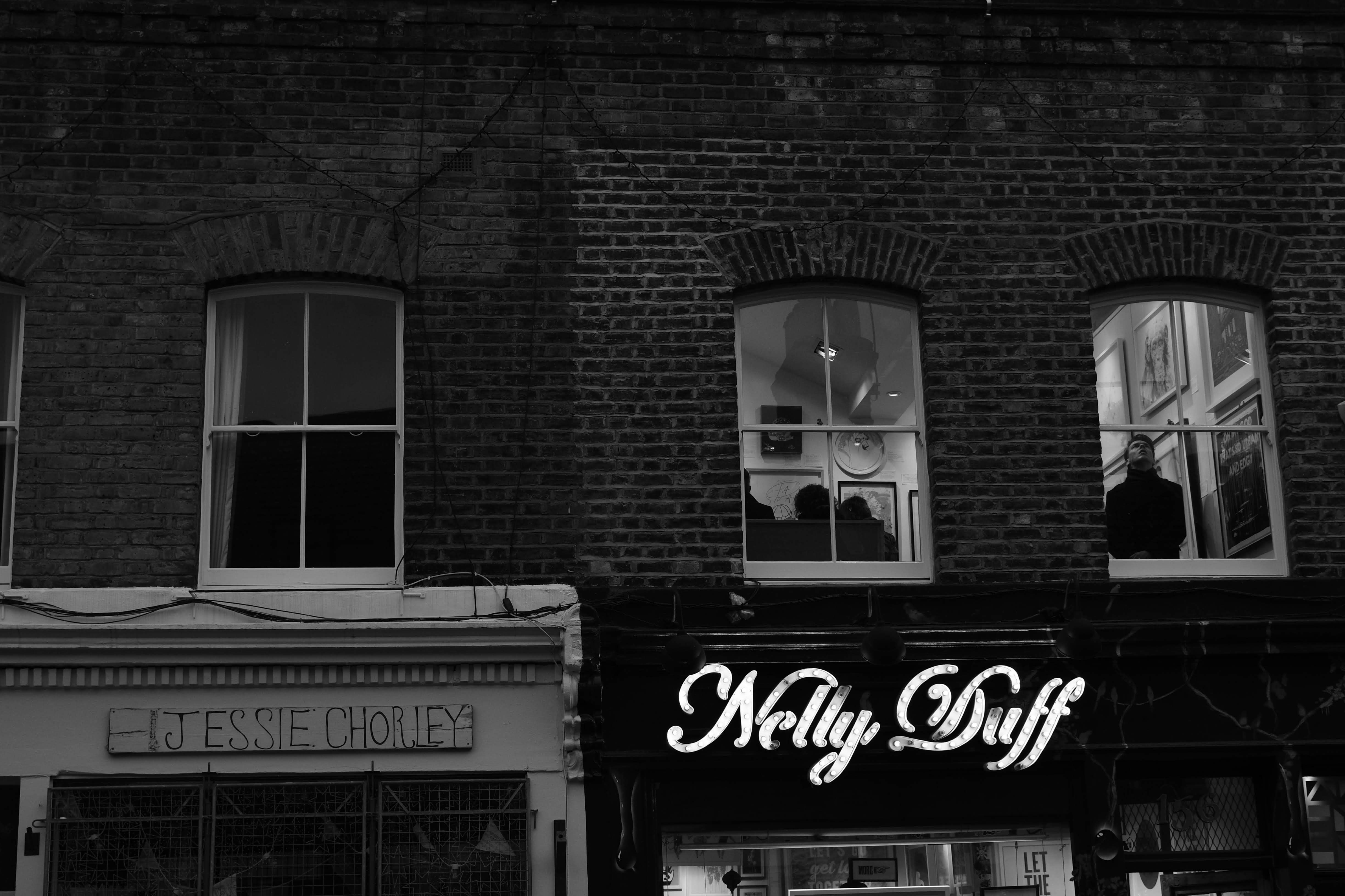 Neon Script and Street Window: A Night in Brick Silence