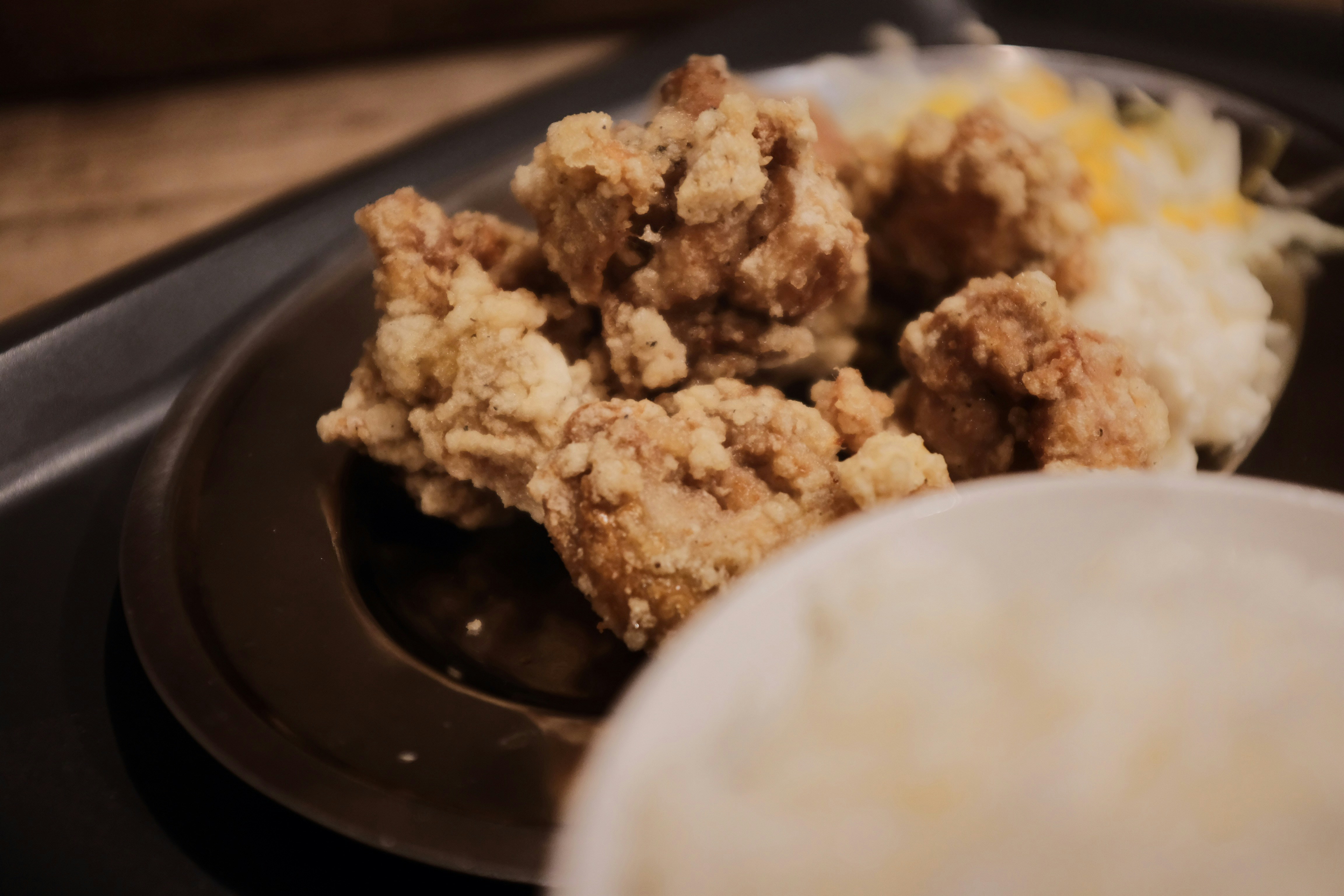 Golden Crunch: Fried Chicken Clusters on a Rustic Plate with Rice