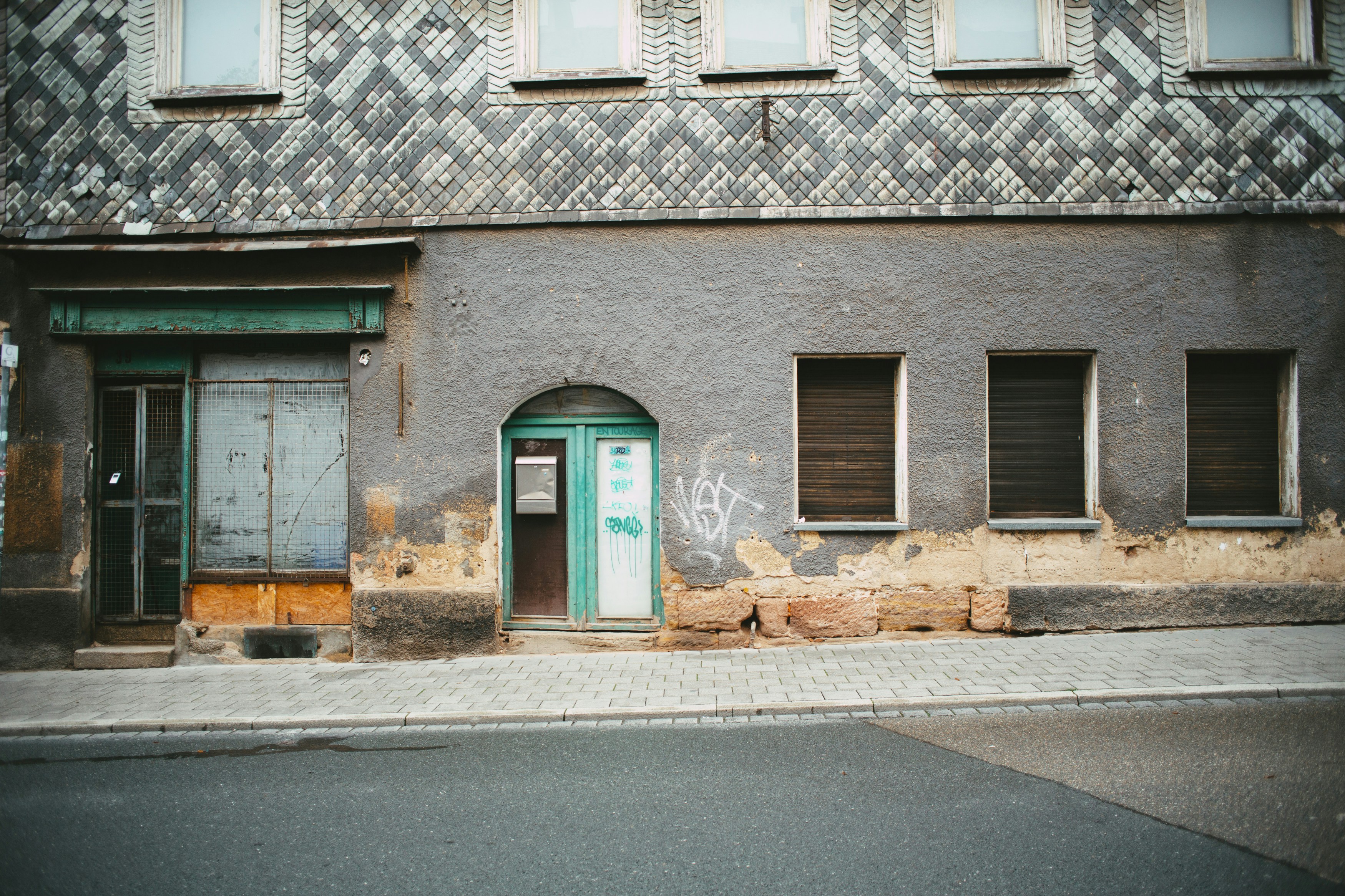 Vintage dilapidated residential and commercial building storefront. Made with analog vintage lens, Leica Elmarit-R 2.8 28mm (Year: 1977)