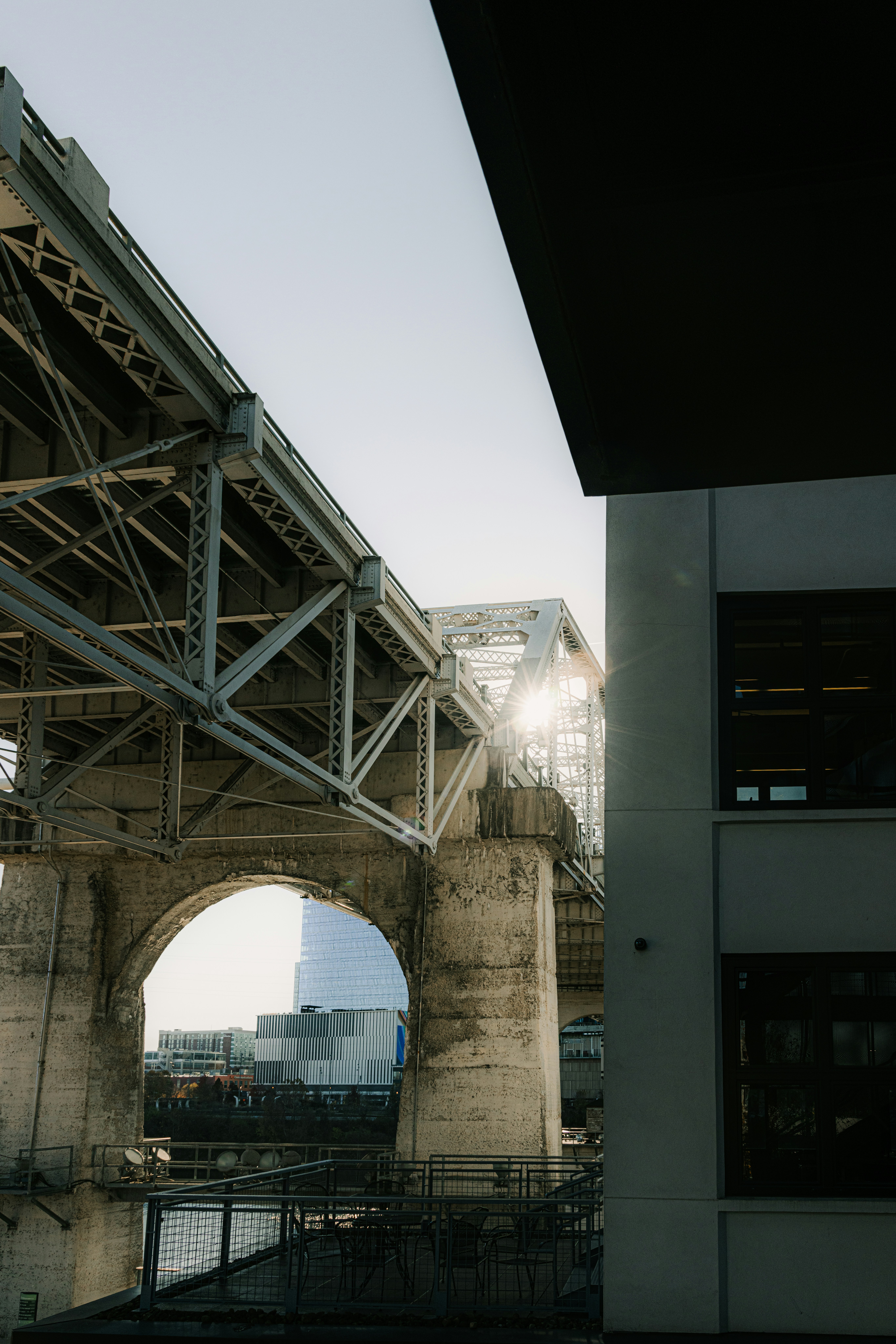 Sunburst Through Steel: A Riverfront Bridge Frame