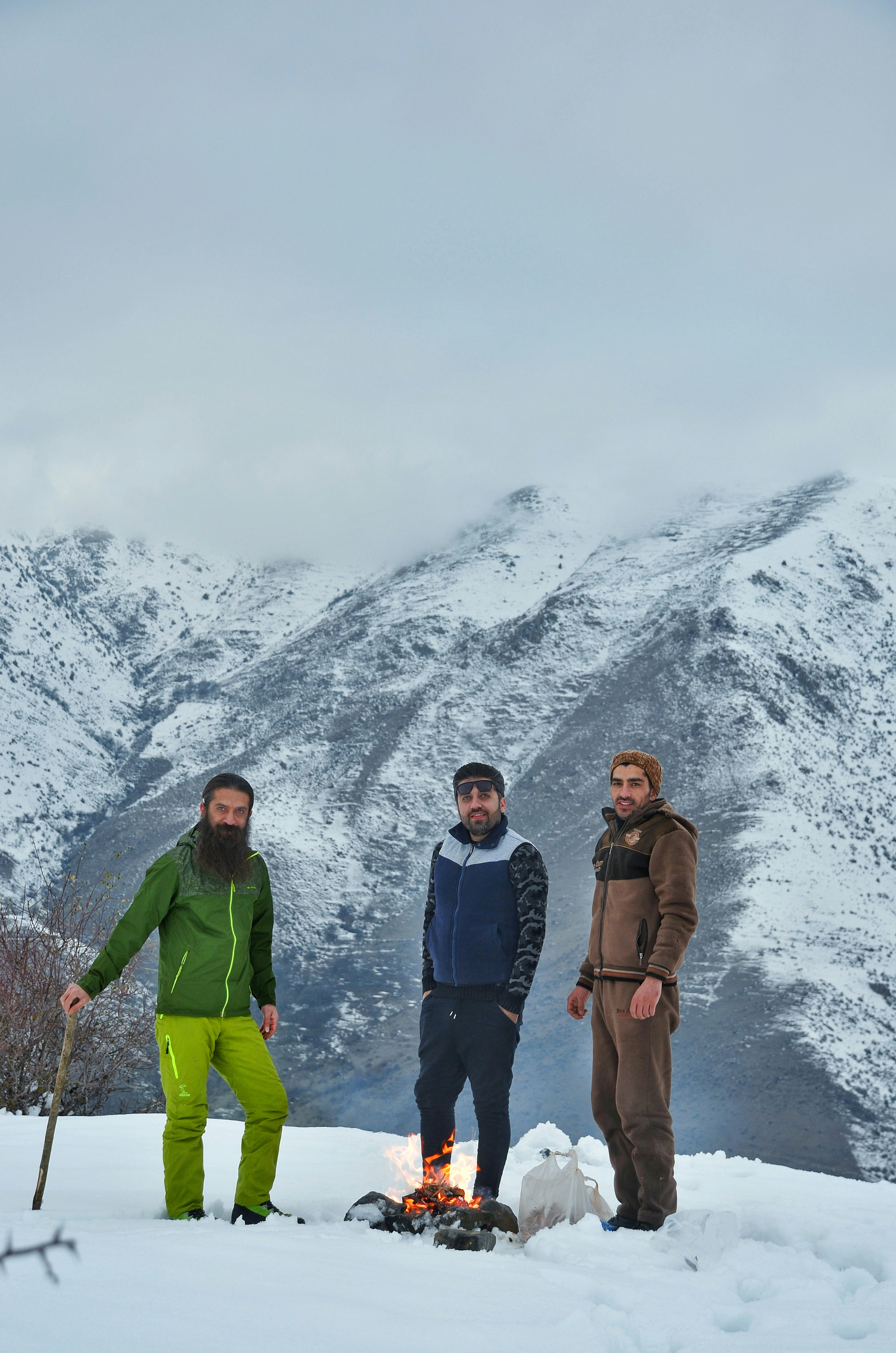 Snowbound Campfire Conclave Beneath Alpine Ridges