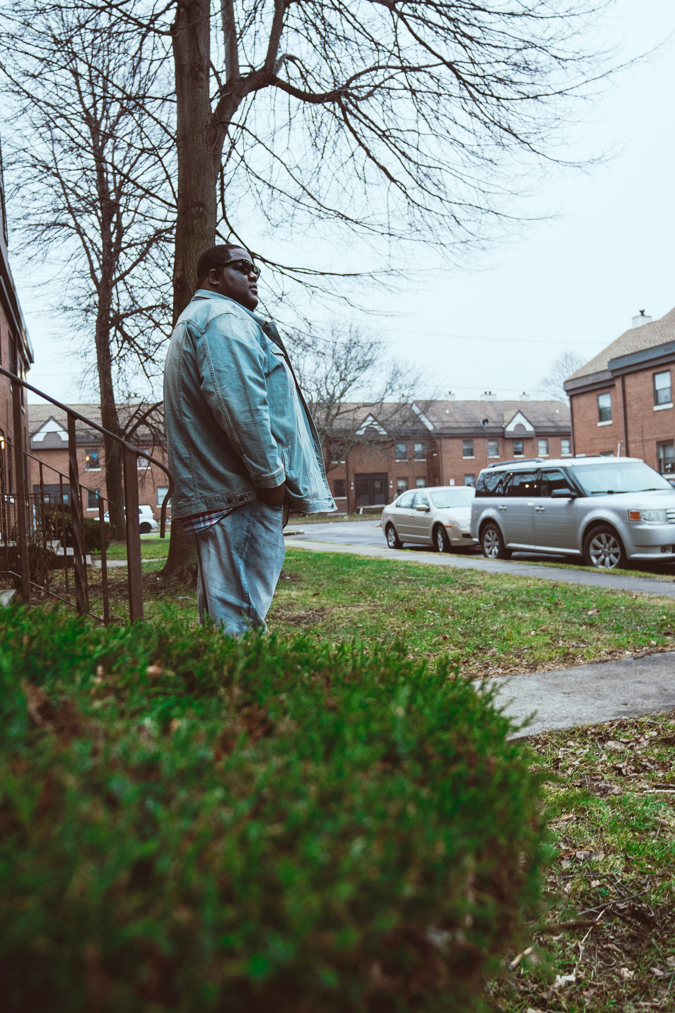 Denim Stance on a Suburban Avenue