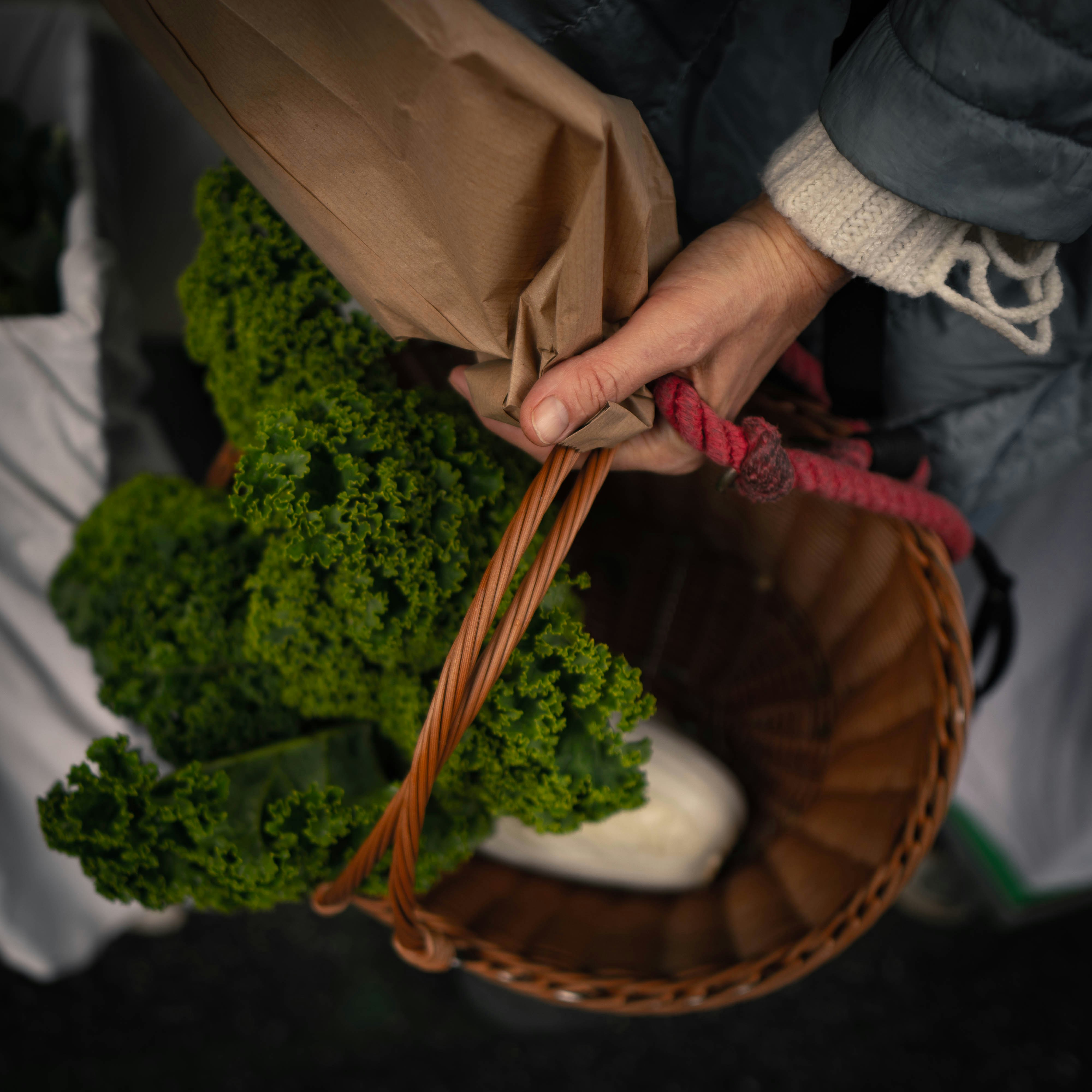 Kale at Hand: A Quiet Market Moment in a Wicker Basket