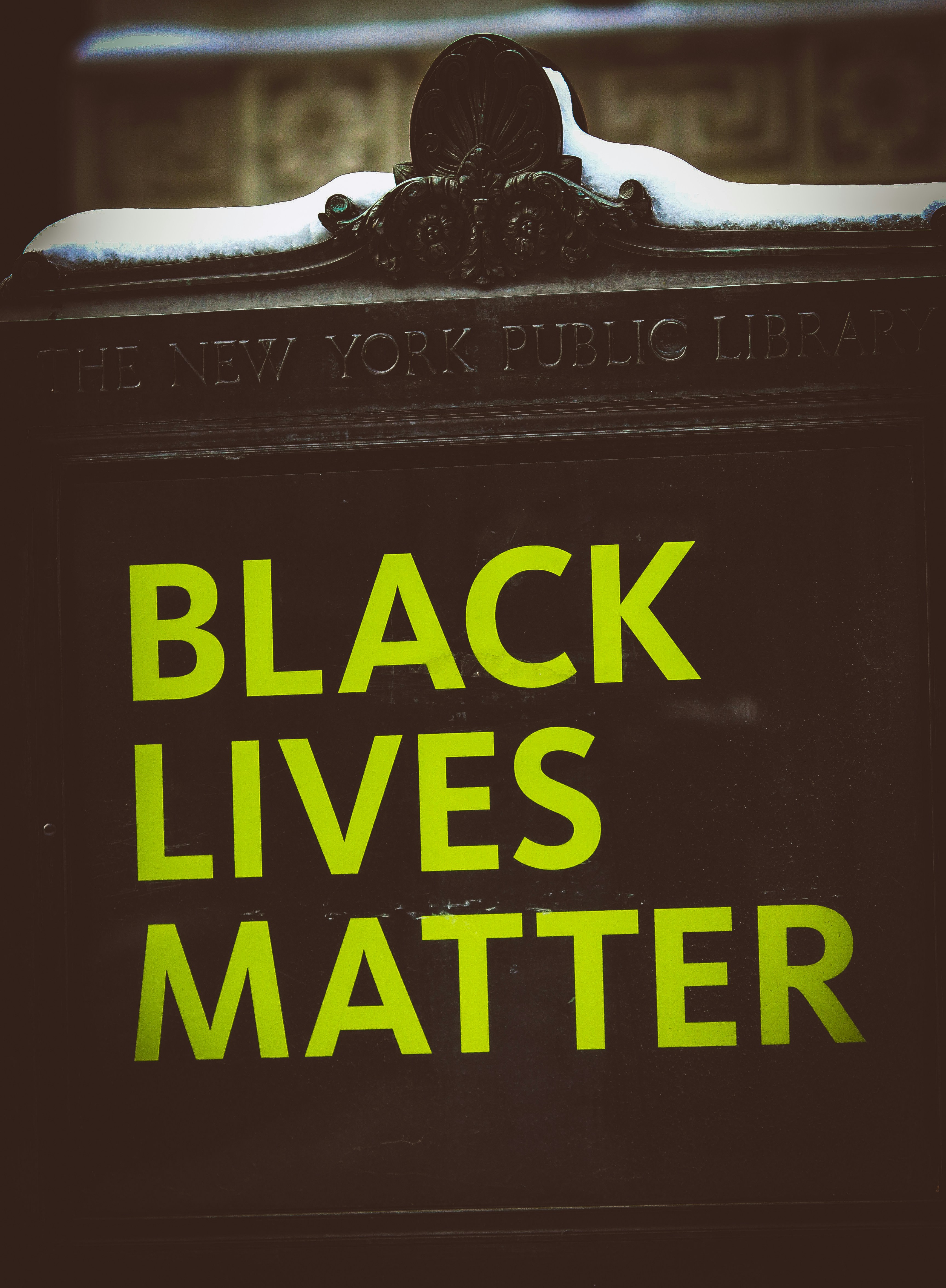 Bright Green 'BLACK LIVES MATTER' on a Snow-Dusted Library Bin