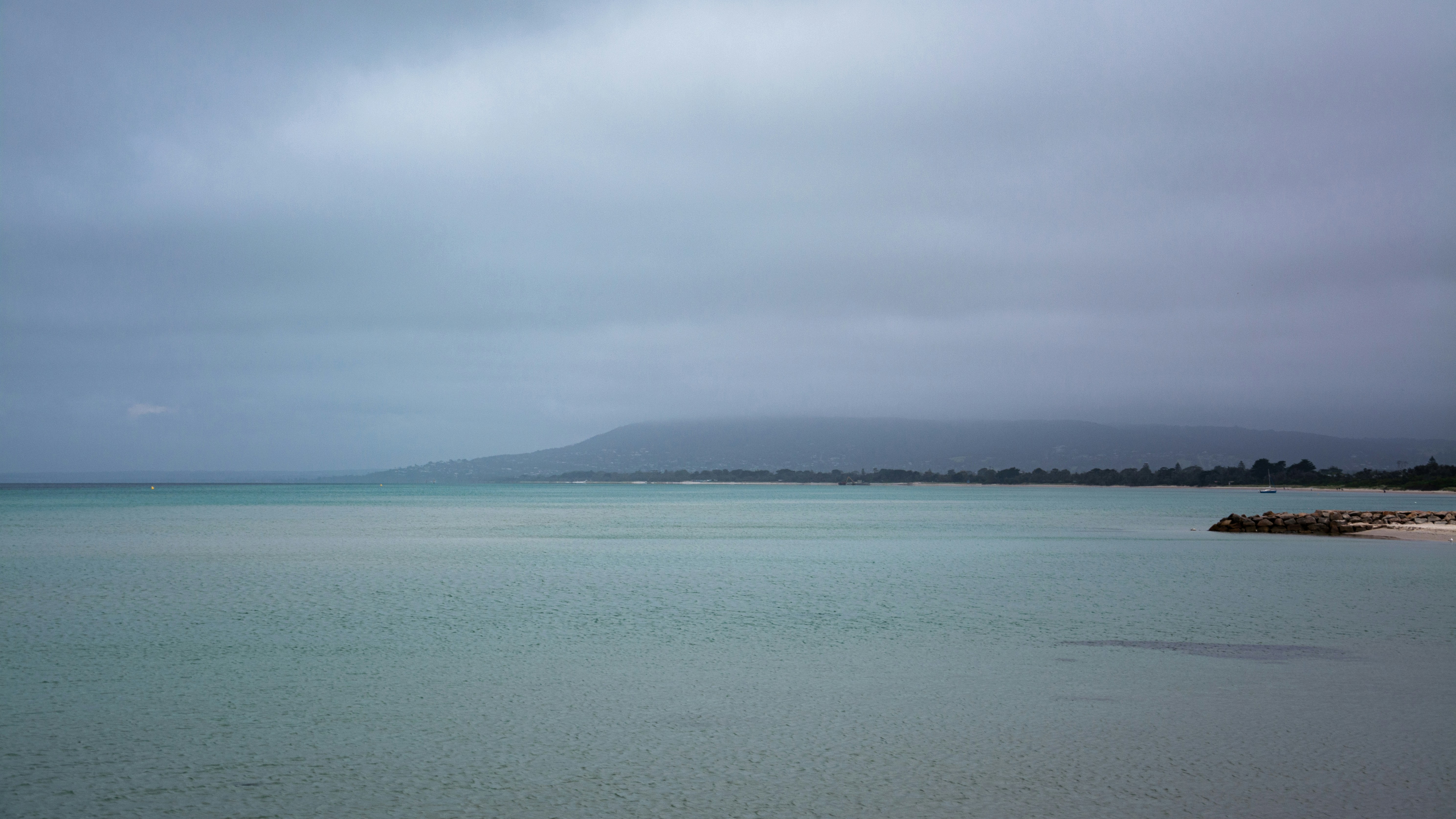 body of water under cloudy sky during daytime
