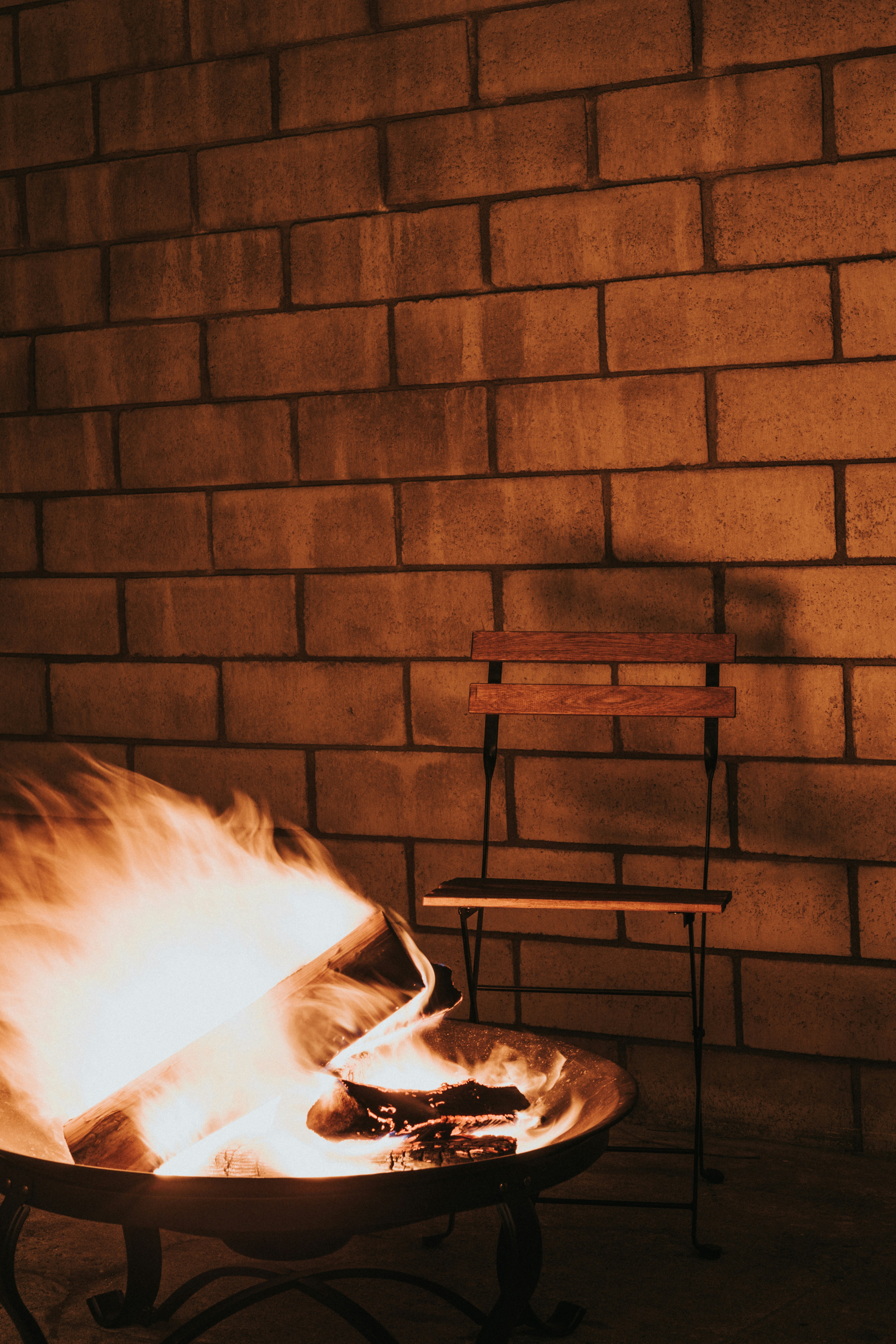 Cozy Fire Serenade: Flame Dancers by the Brick Wall